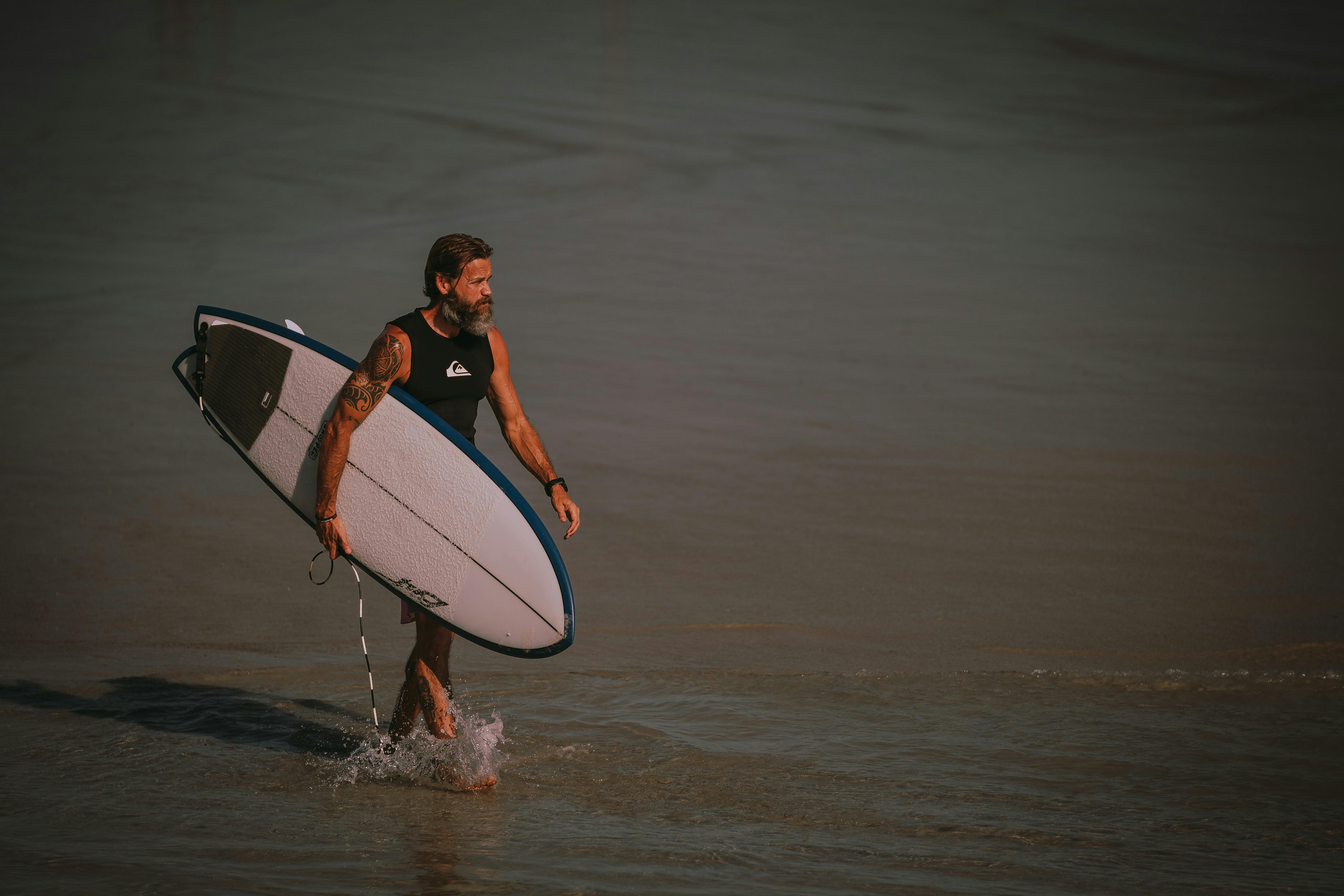 Surfer Carrying Surfboard · Free Stock Photo