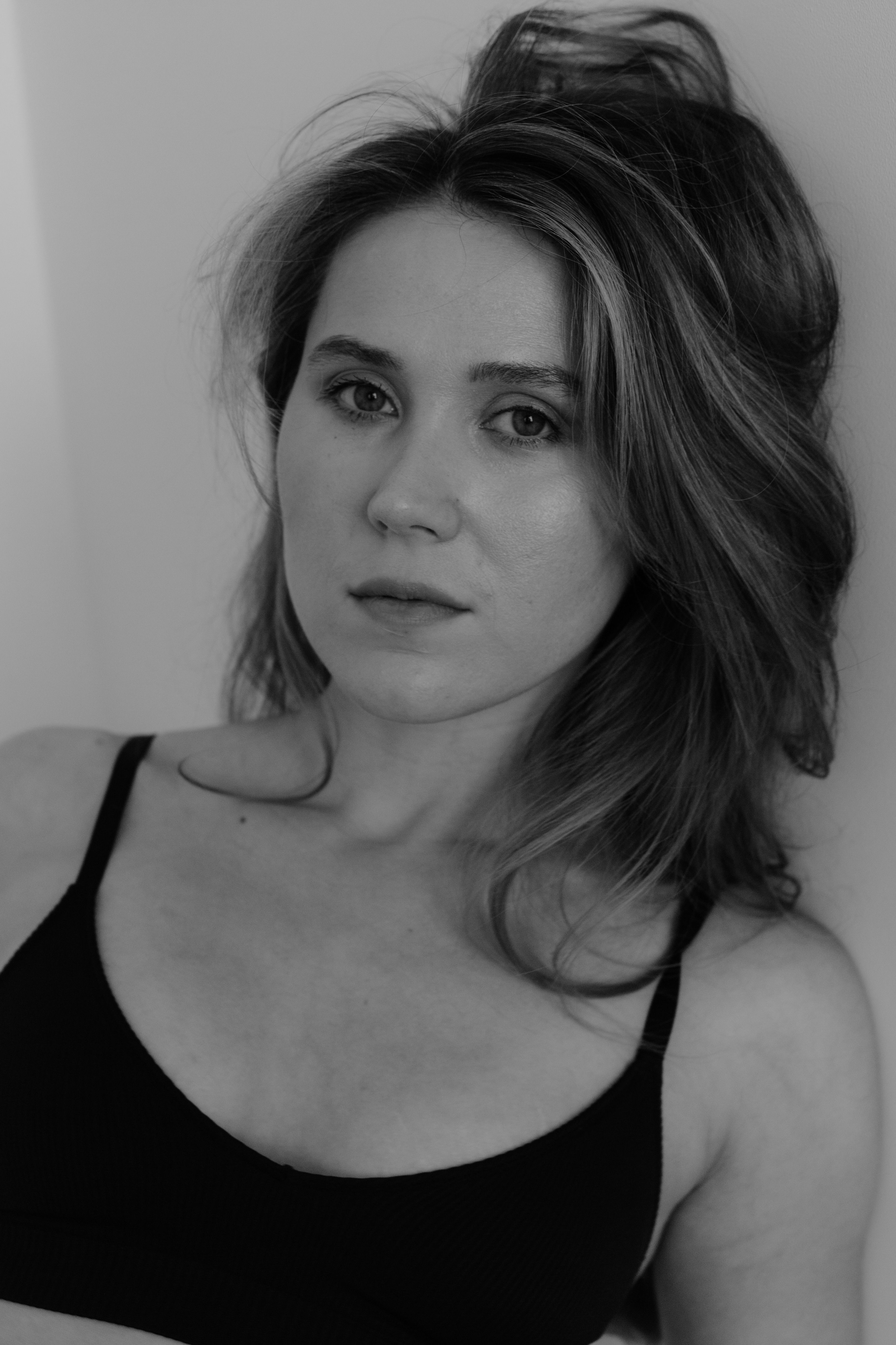 Black And White Photo Of A Seductive Young Woman Taking Off Her Jacket