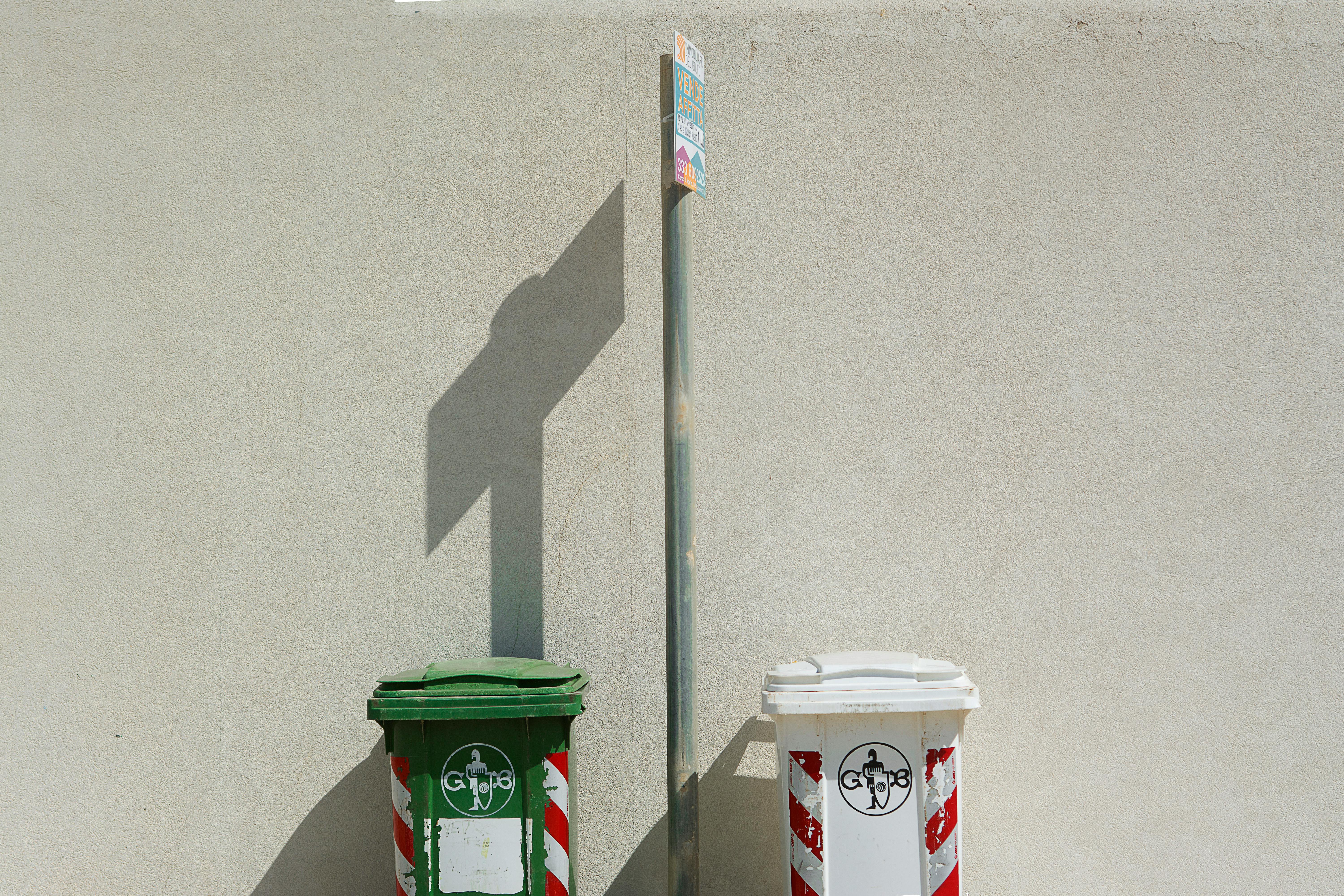 Post between Garbage Bins · Free Stock Photo