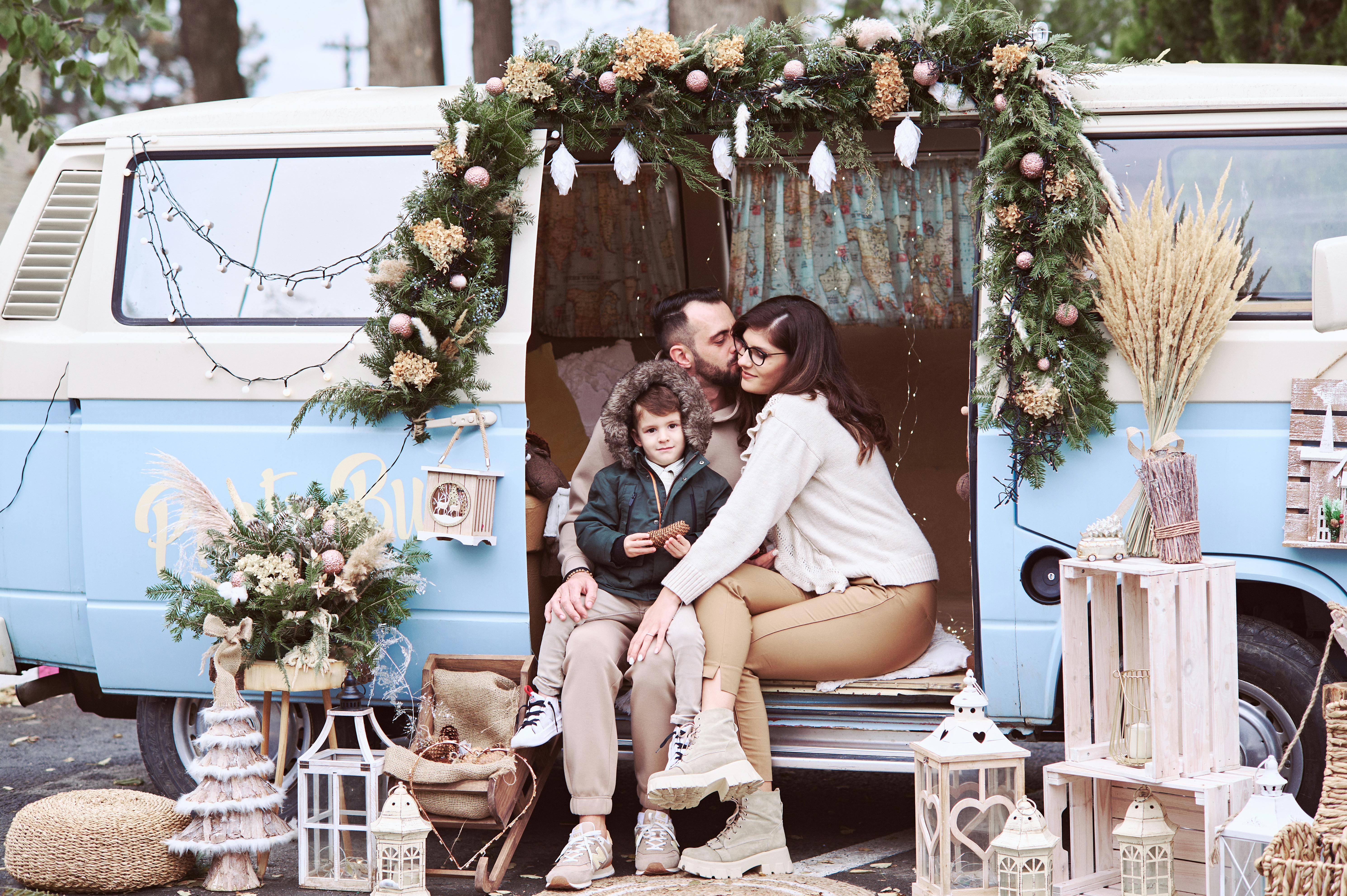 Couple with a Child Posing in a Van Decorated with Christmas Decoration ...