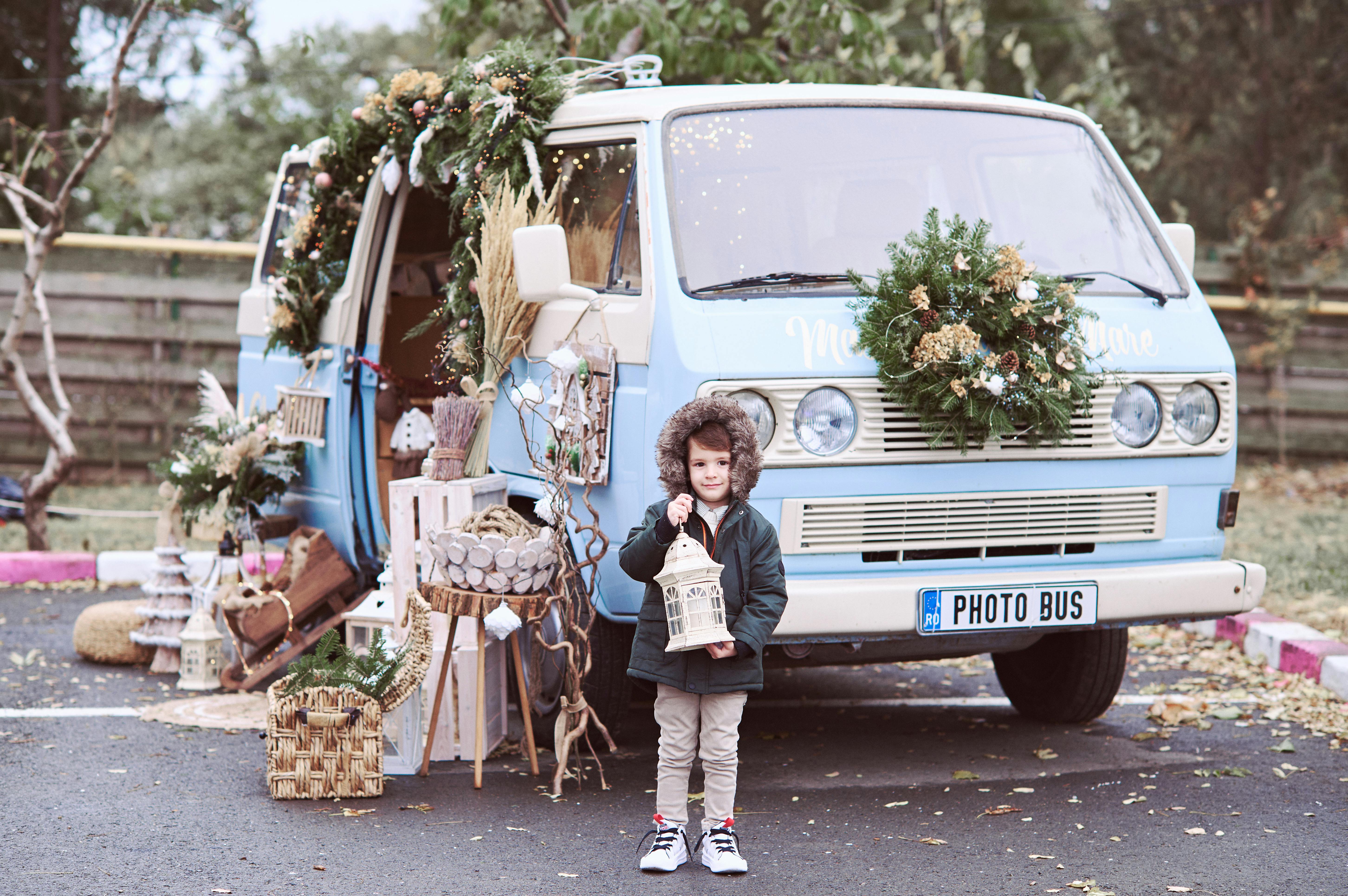 Boy Standing by Decorated Van for Christmas · Free Stock Photo