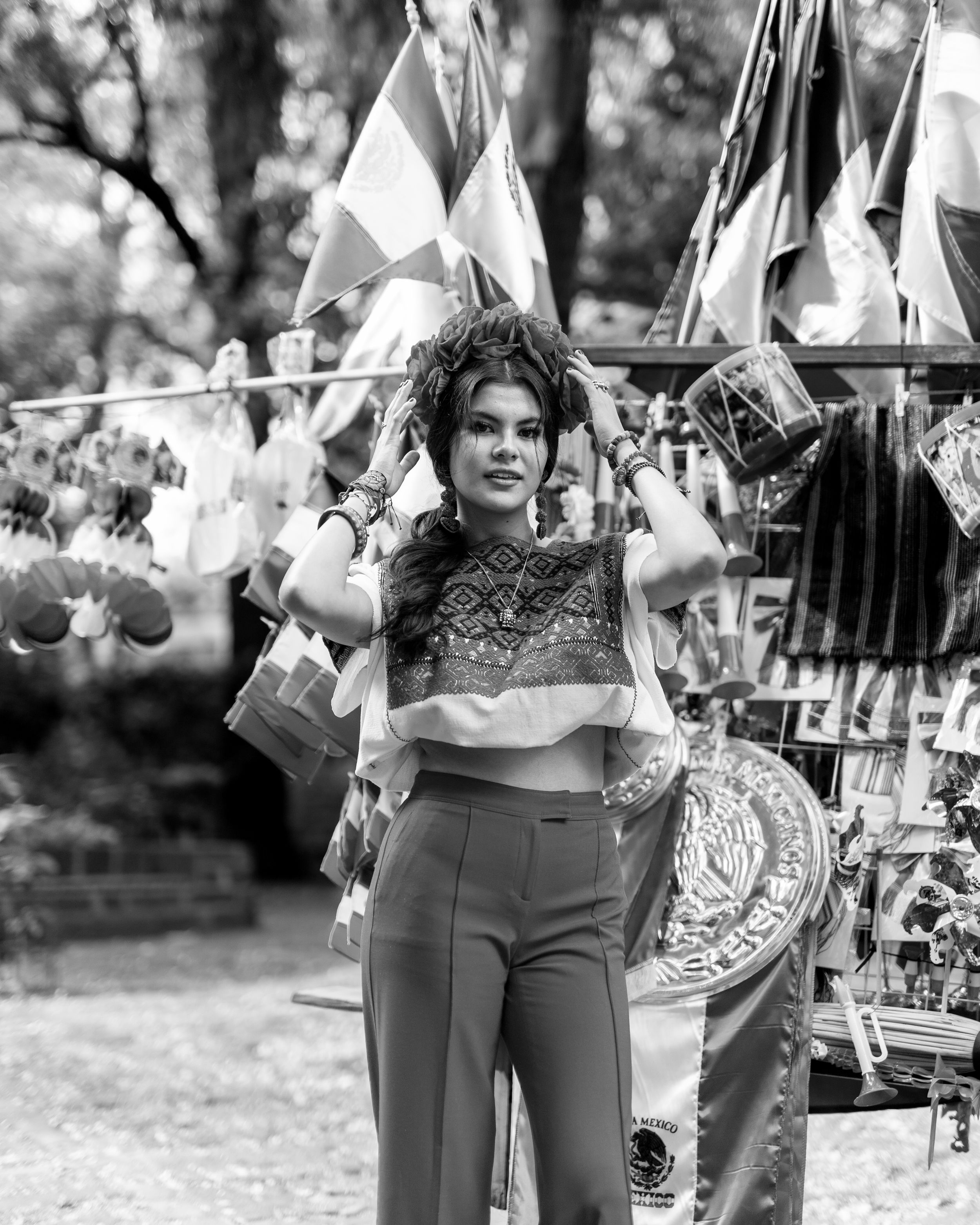 A woman standing in front of a flag with a bunch of flags · Free Stock ...