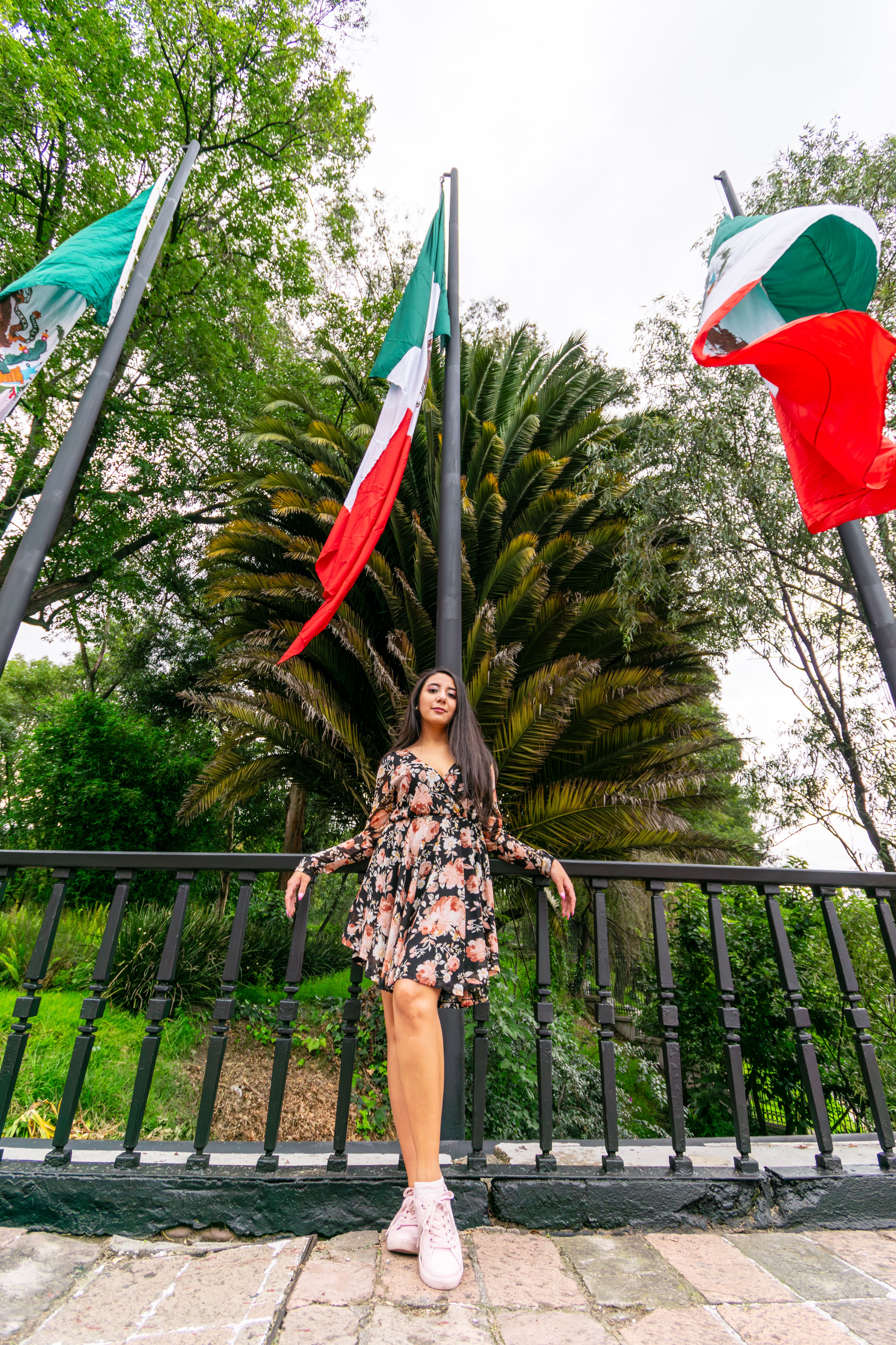 Woman in Sundress Standing by Flags of Mexico at Park · Free Stock Photo