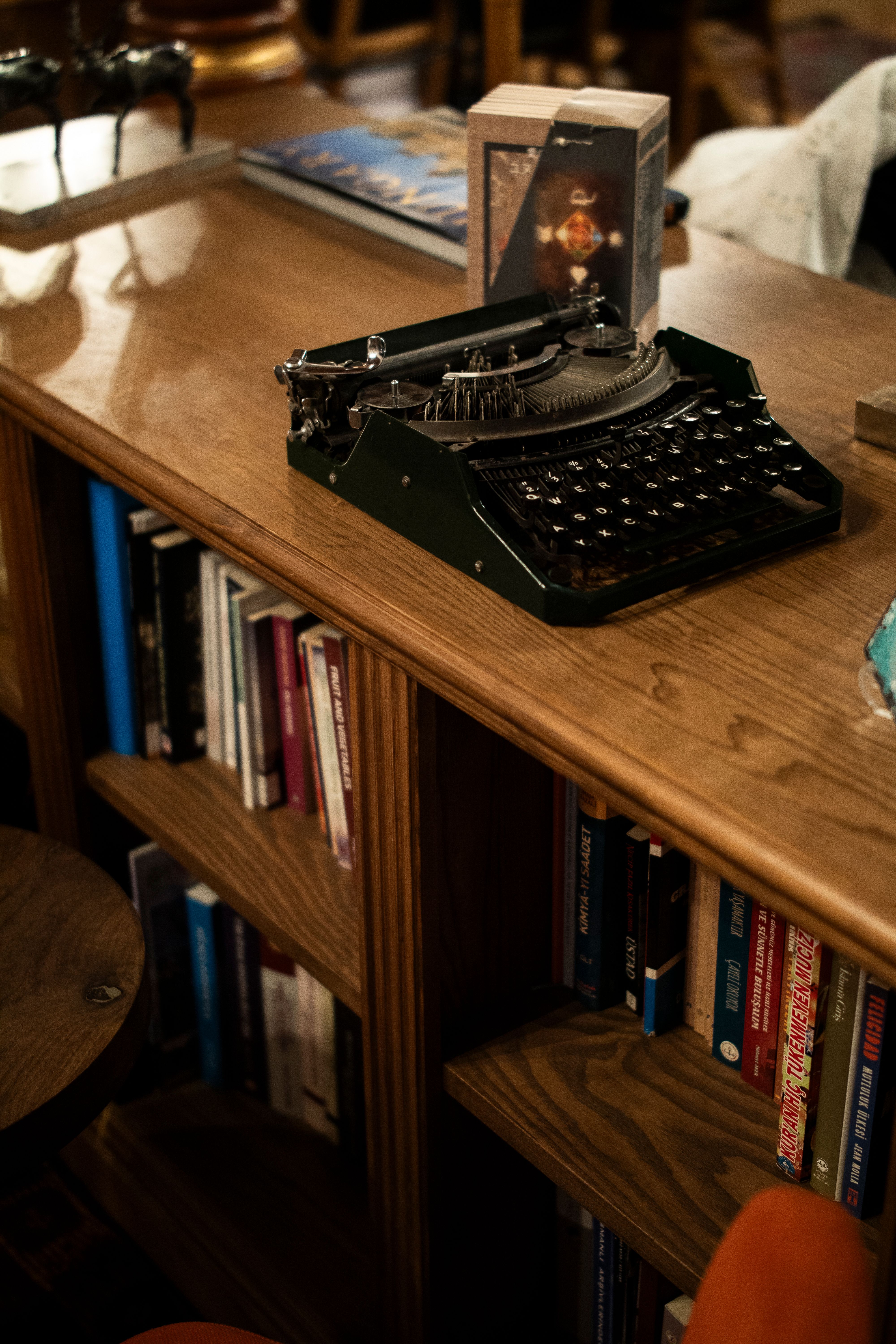 Vintage Typewriter and a Bookcase · Free Stock Photo