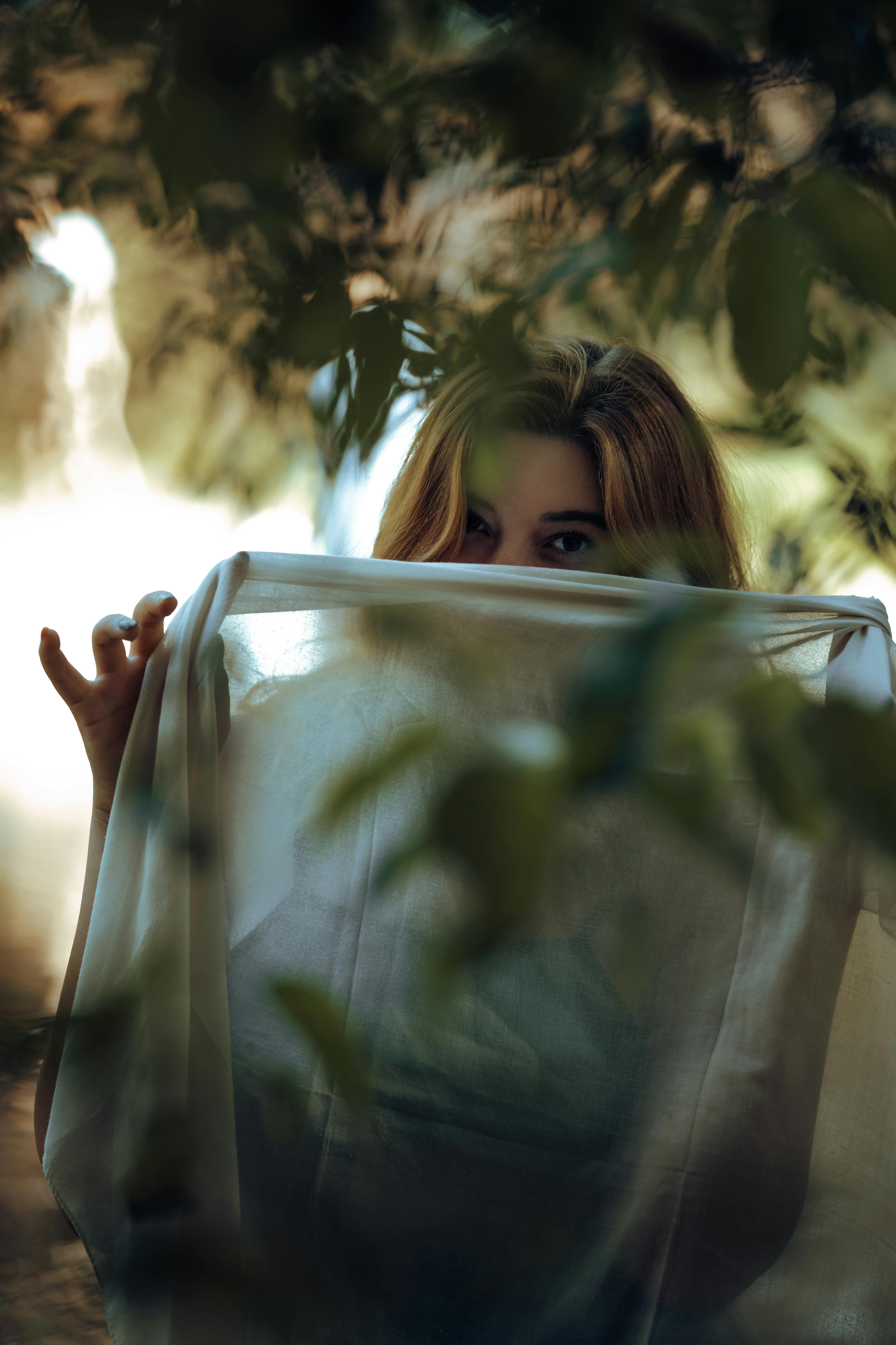 Young Woman Hiding behind Fabric in Park · Free Stock Photo