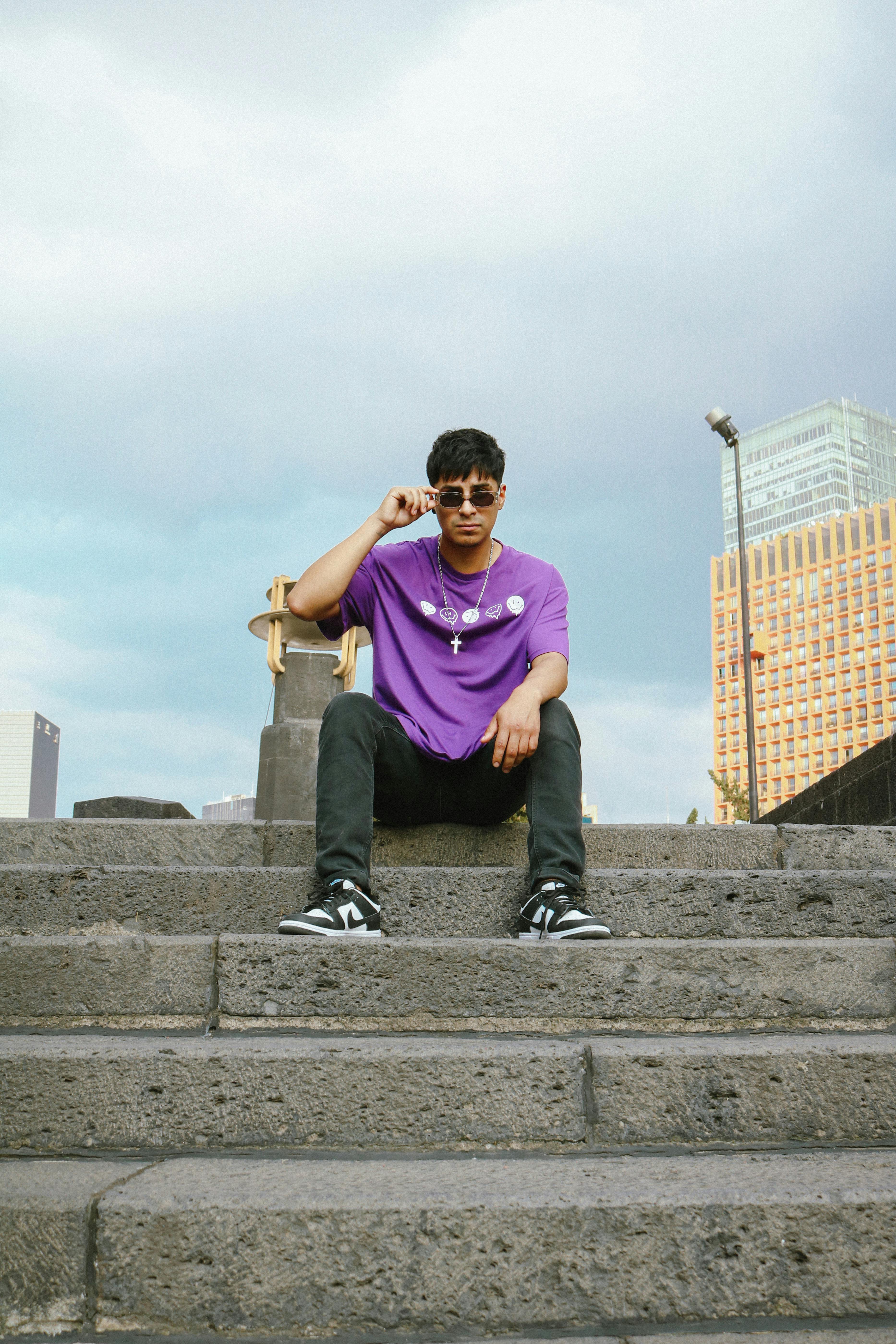 Man in Purple T-shirt on Steps · Free Stock Photo