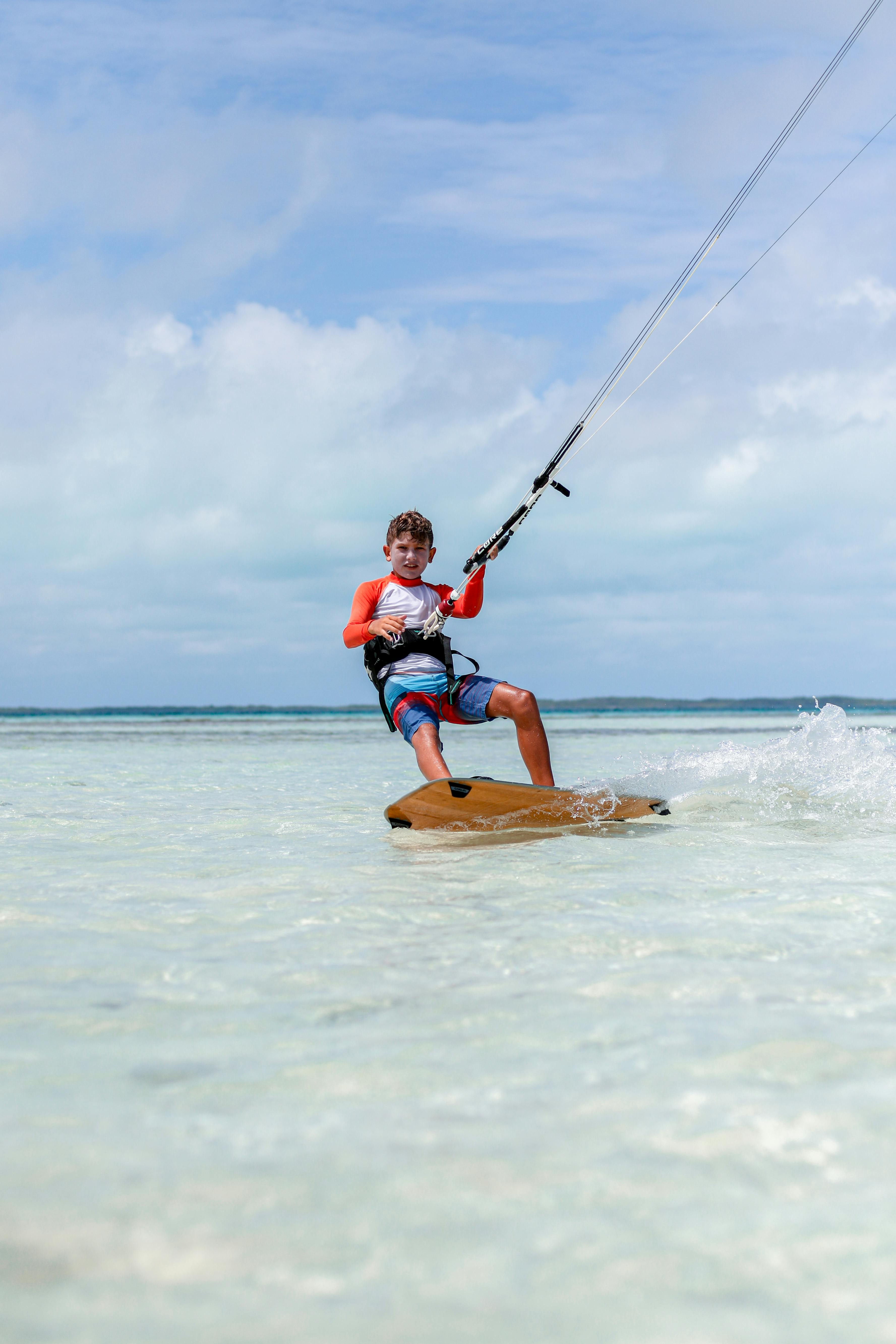 Boy Kitesurfing in Ocean · Free Stock Photo