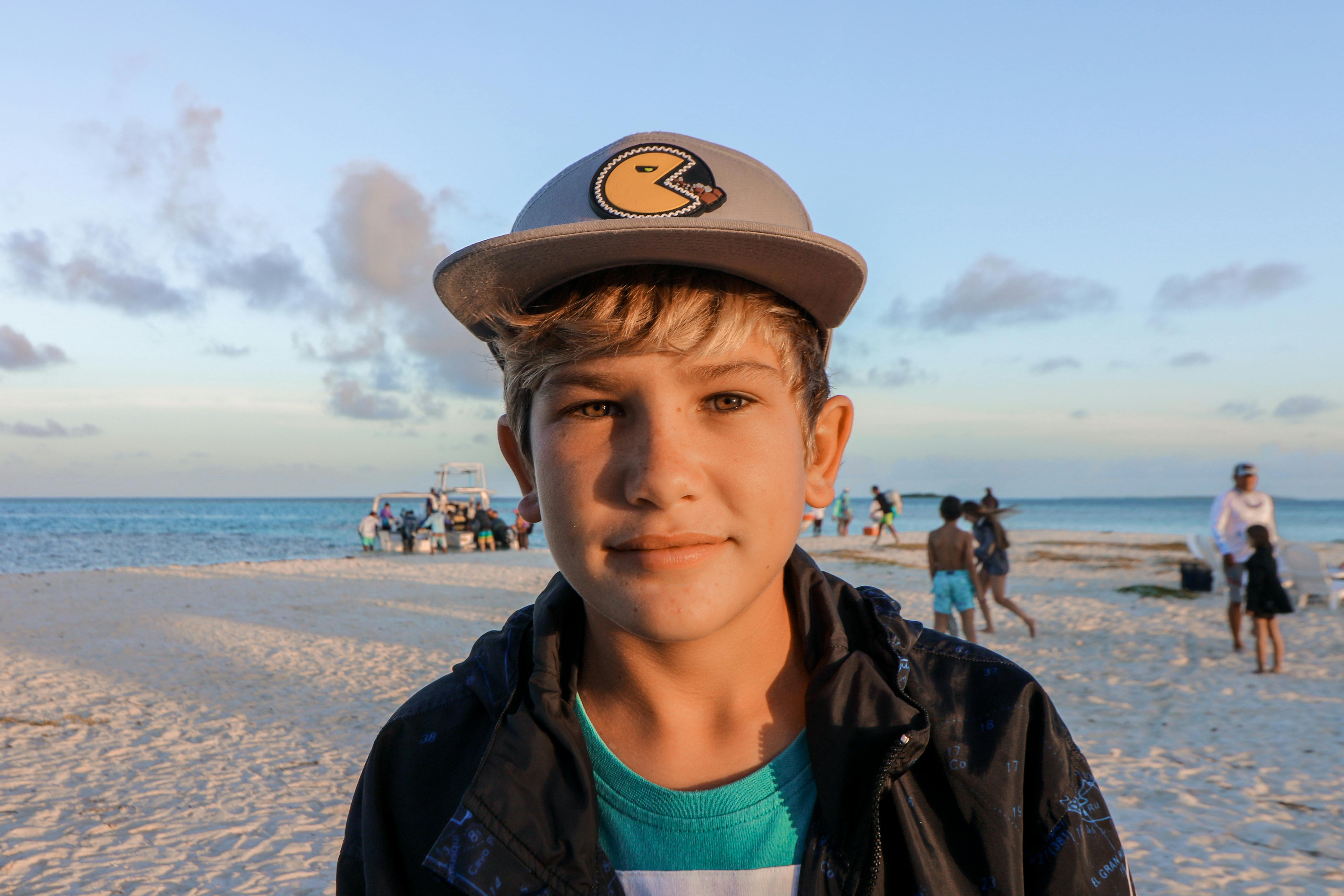 Boy in Cap on Beach · Free Stock Photo