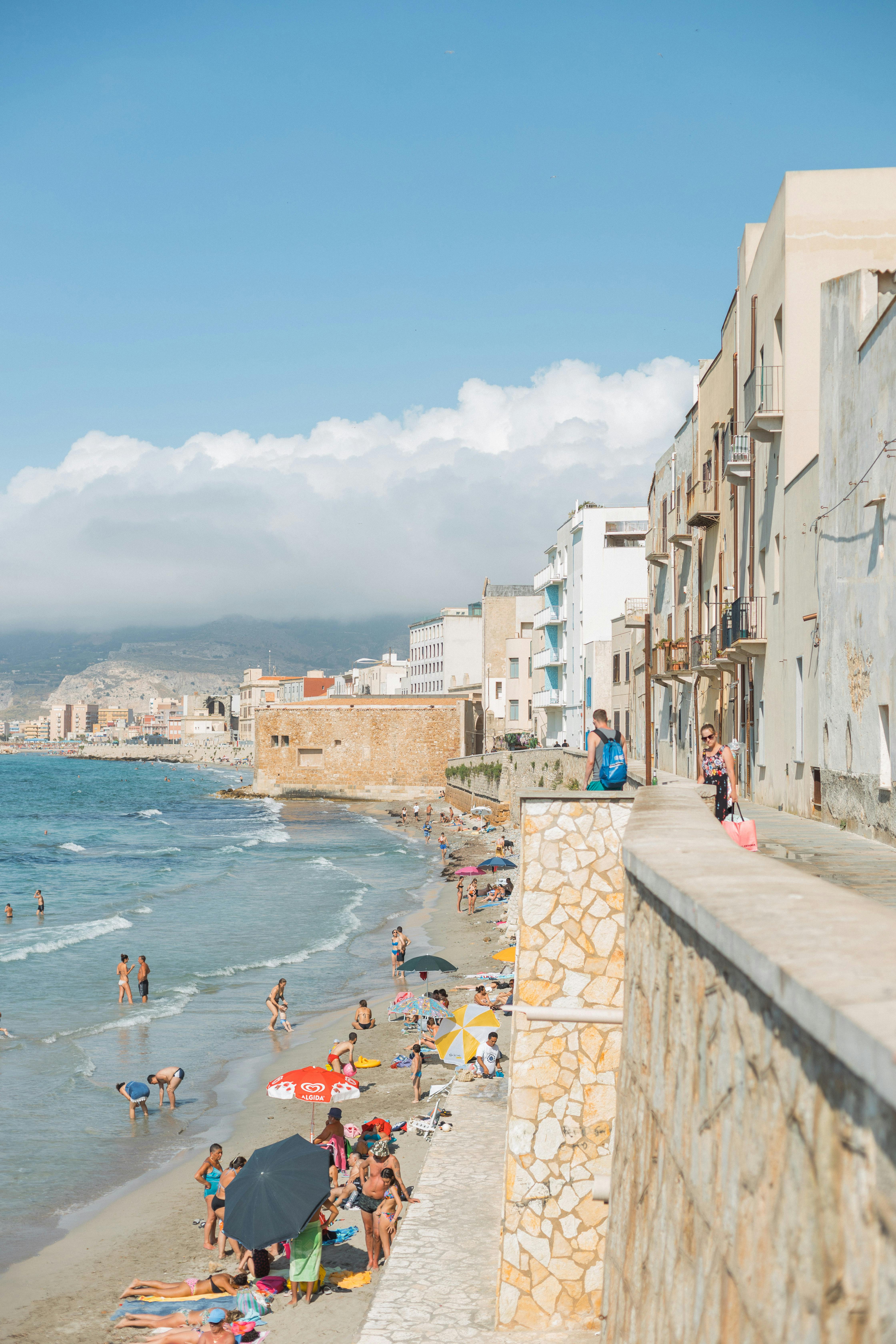 Tourist at Beach by Waterfront in Trapani · Free Stock Photo