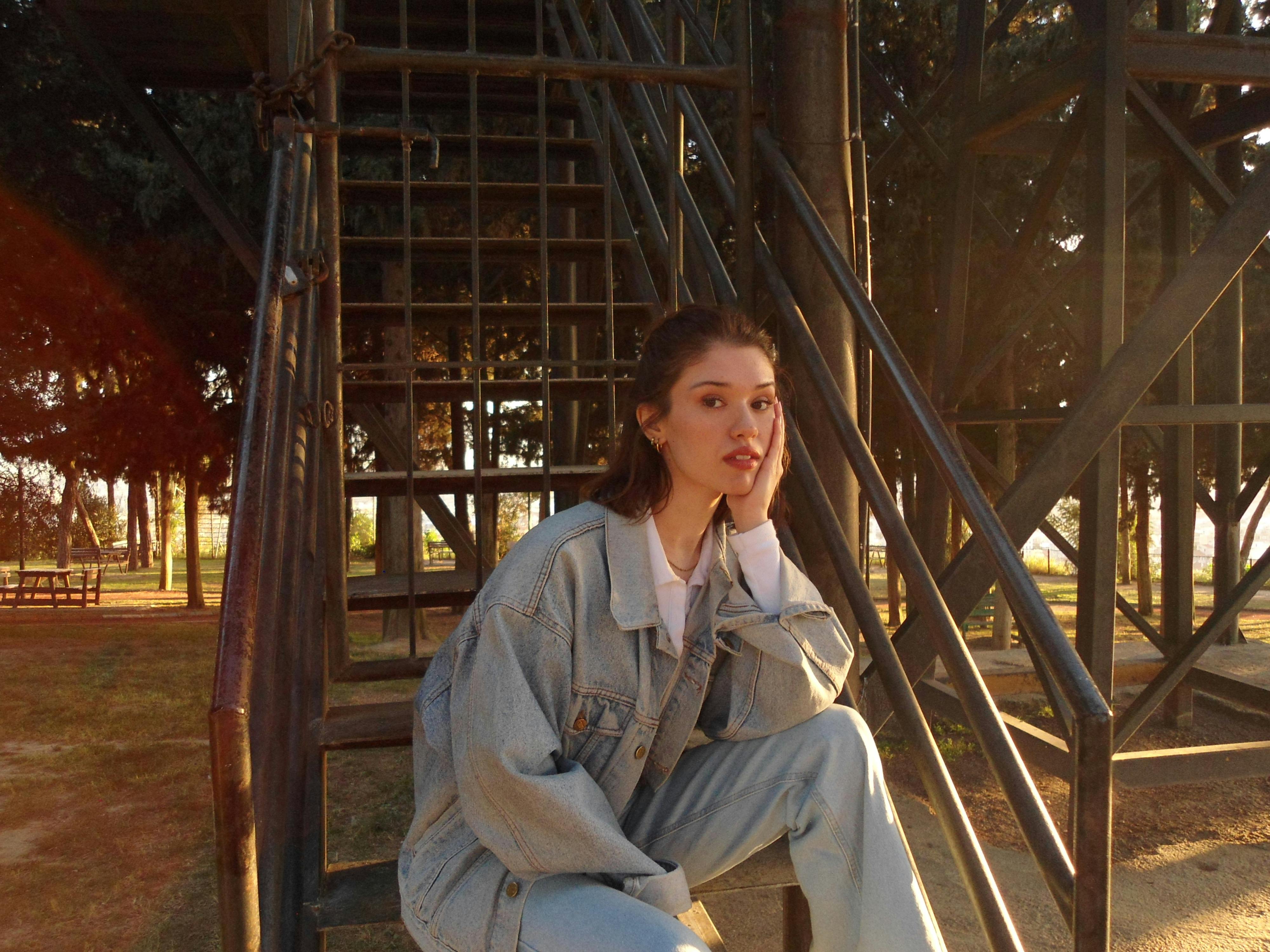 Woman in Jean Jacket Sitting on Stairs · Free Stock Photo