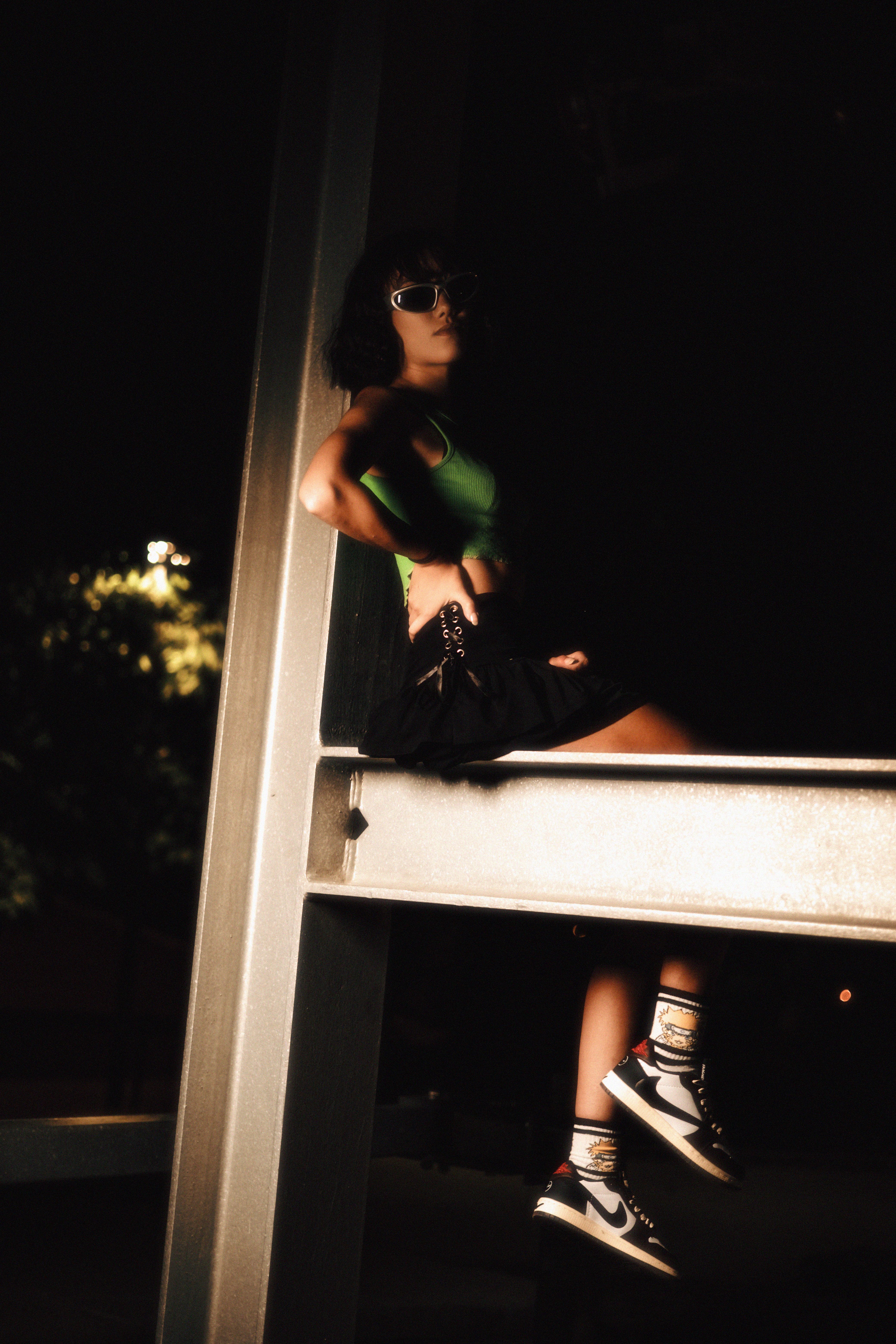 Woman Posing on Steel Beam at Night · Free Stock Photo
