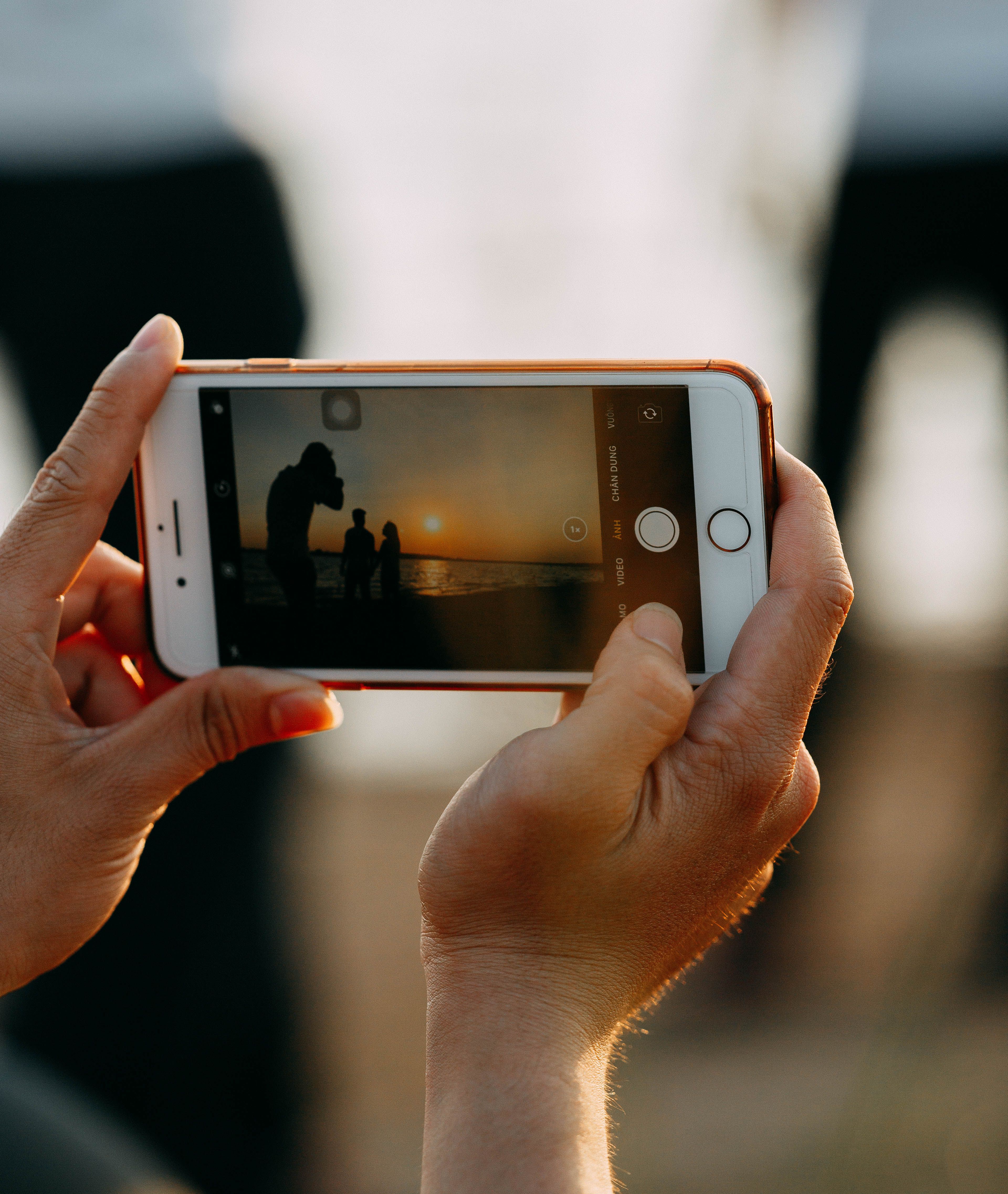 Hands Holding Smartphones and Recording Videos of Model · Free Stock Photo