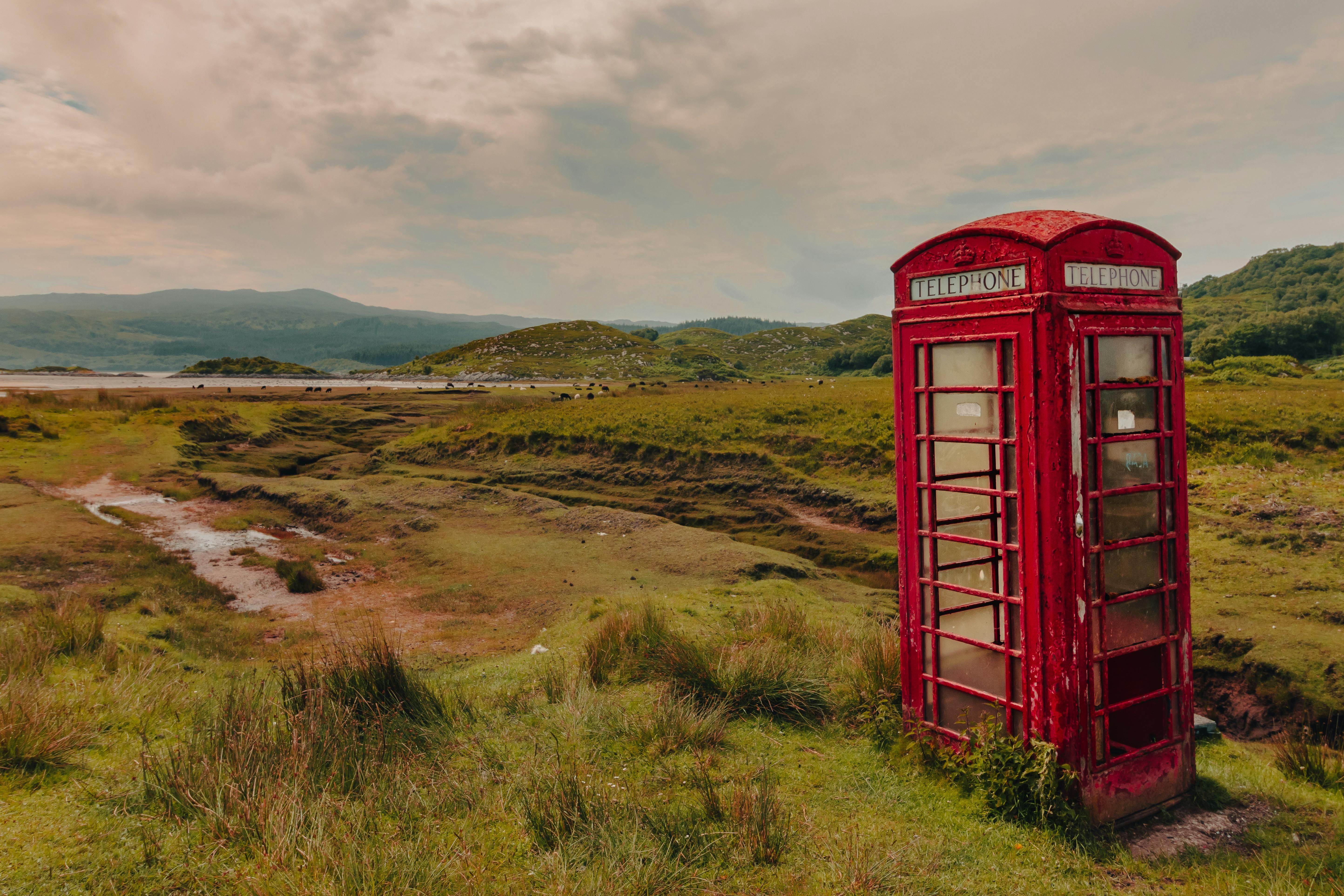Red Telephone Booth on the Sidewalk With Snow · Free Stock Photo