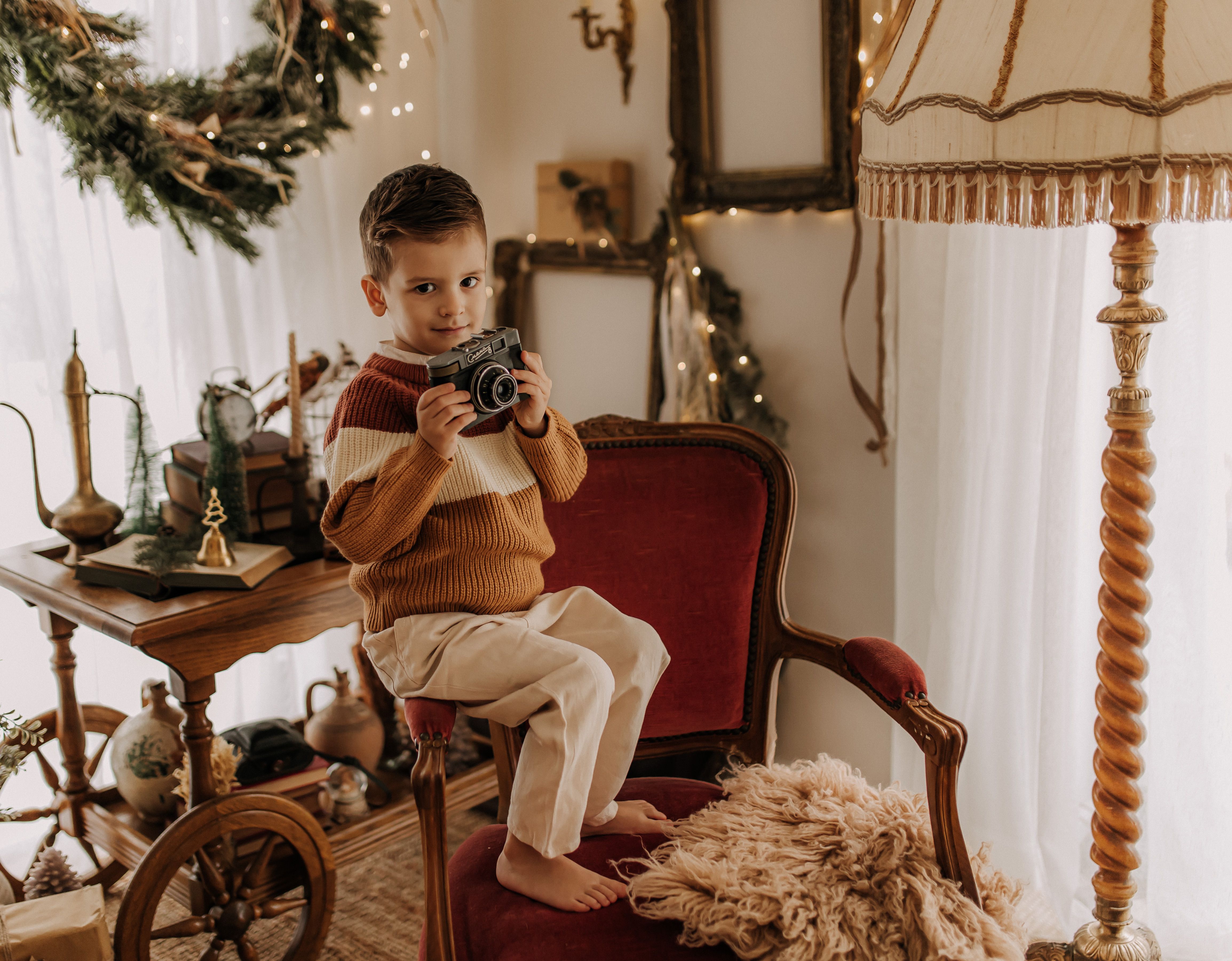 Cute Little Boy with Camera Sitting on Armchair · Free Stock Photo