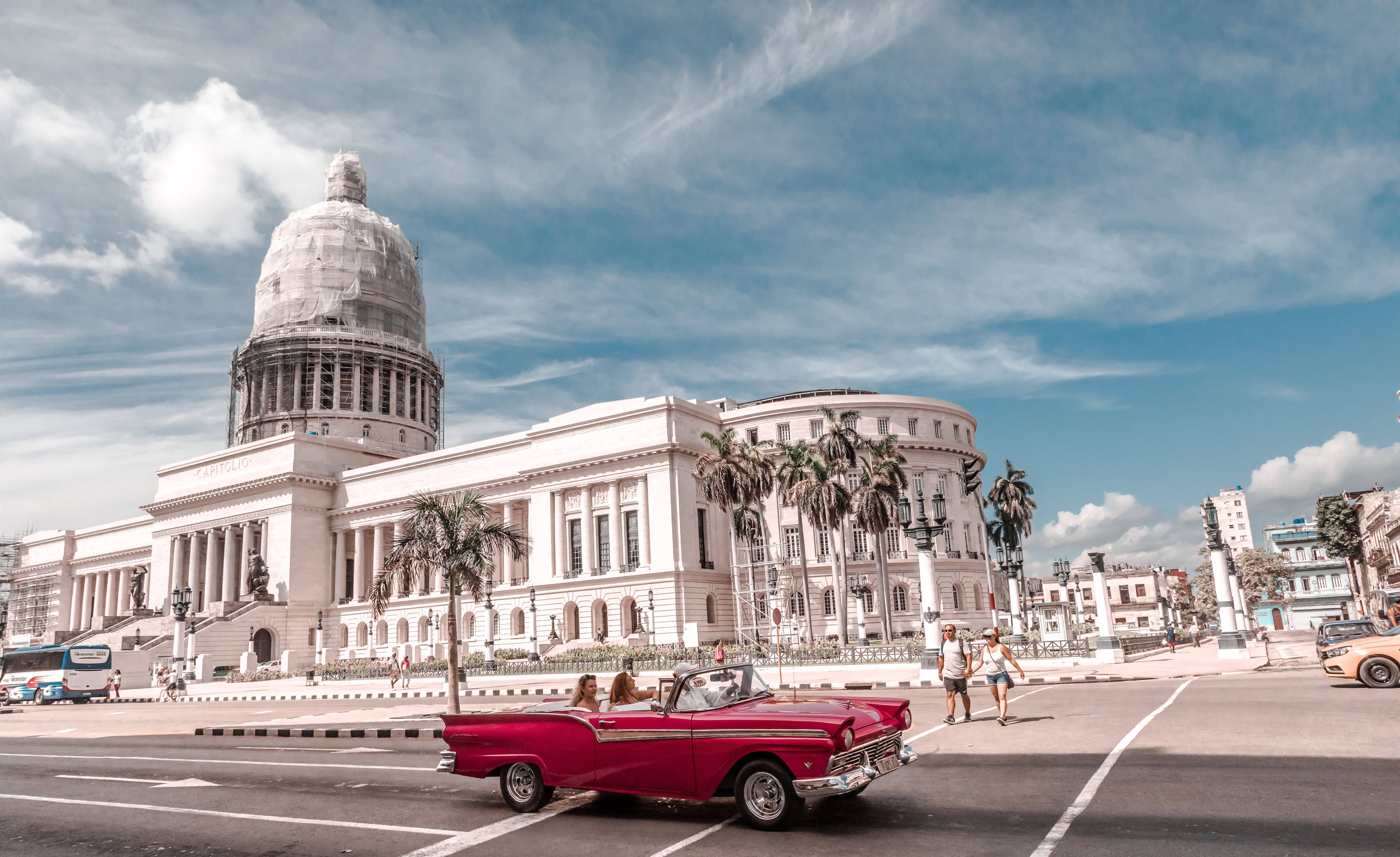 Red Vintage Convertible Car Driving Past National Capitol of Cuba in ...