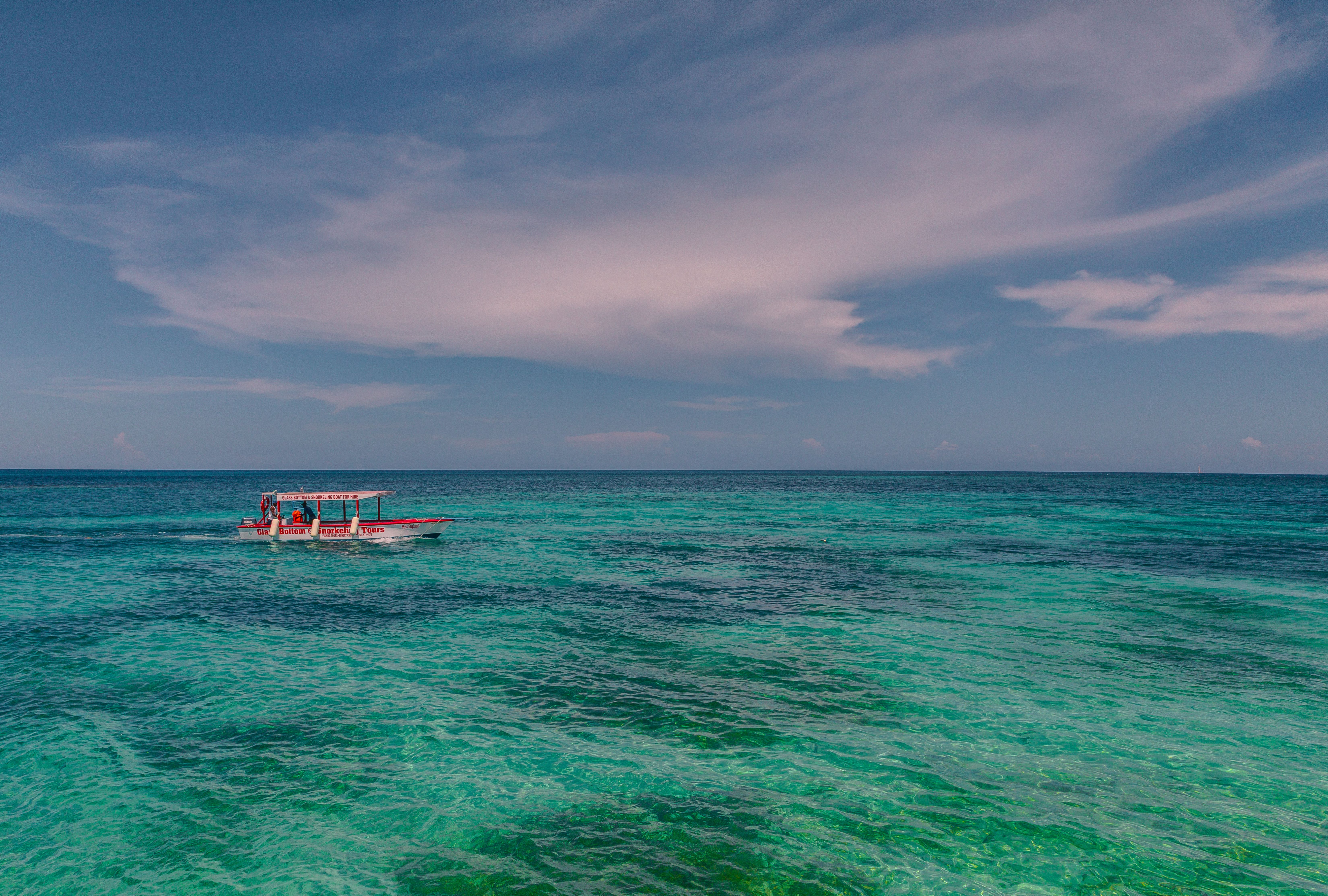 Motor Boat Sailing on a Turquoise Ocean Surface · Free Stock Photo