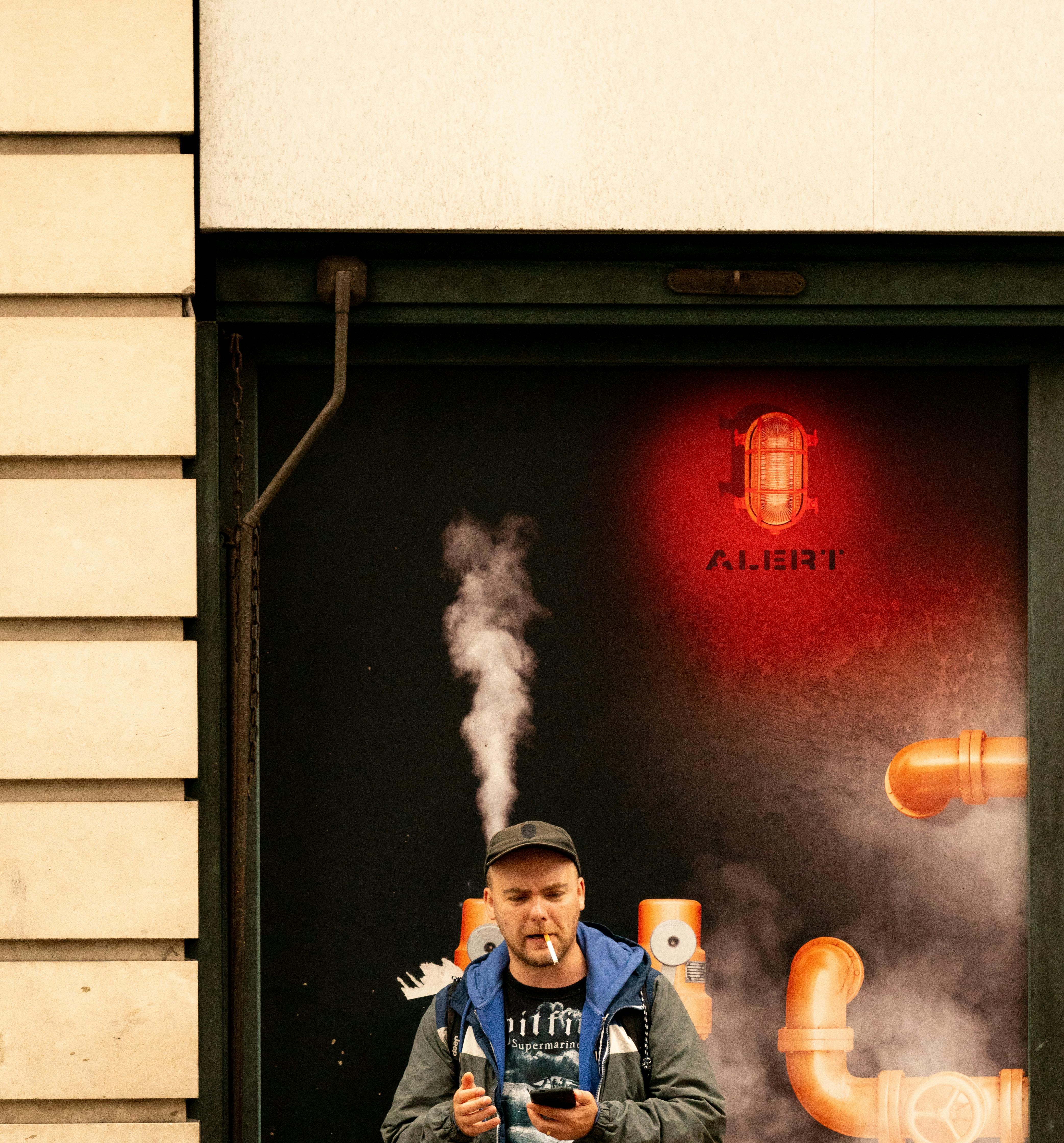 Smoking Man against Mural · Free Stock Photo