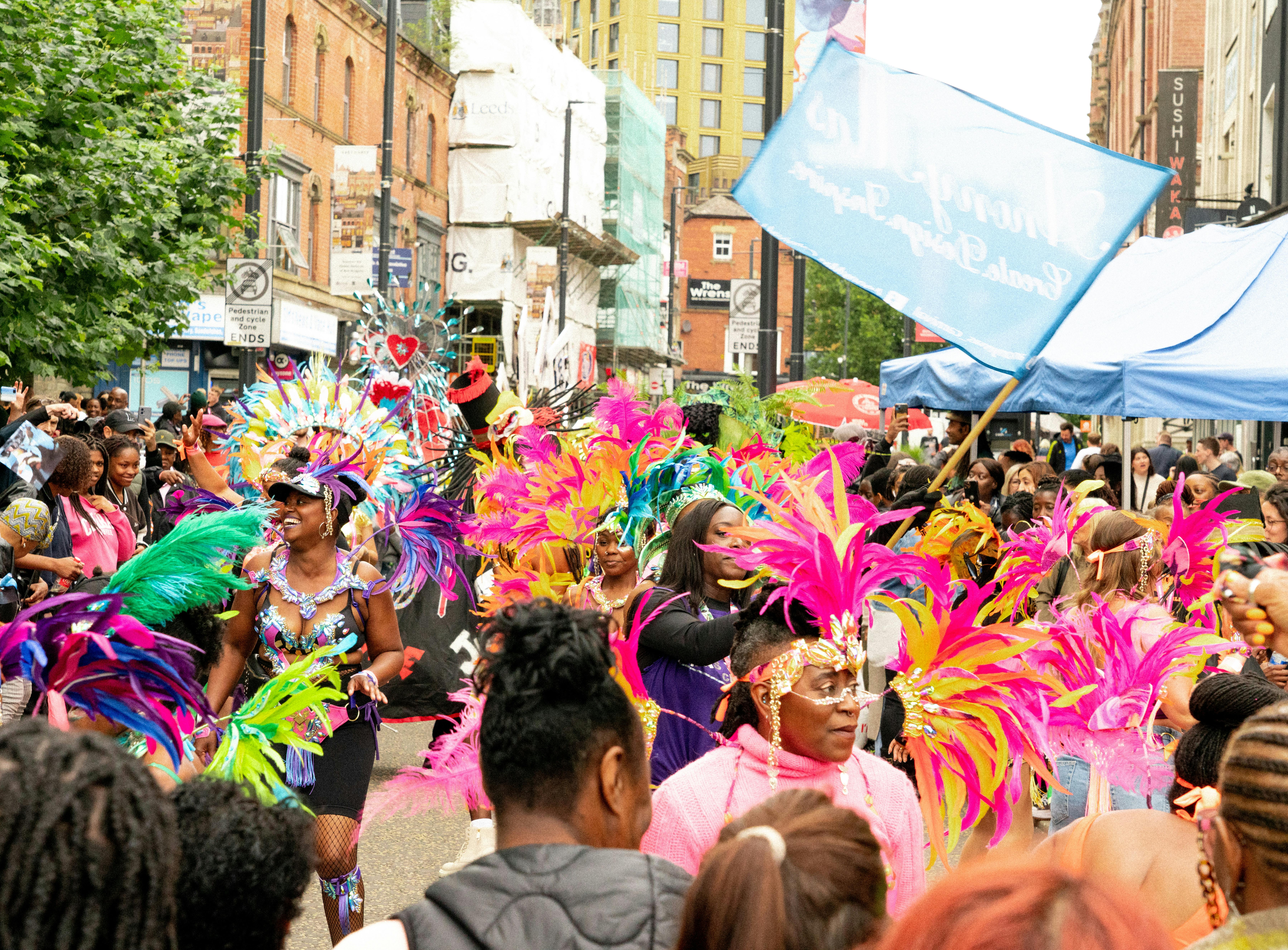 People in Colorful Costumes on the Street at a Parade · Free Stock Photo