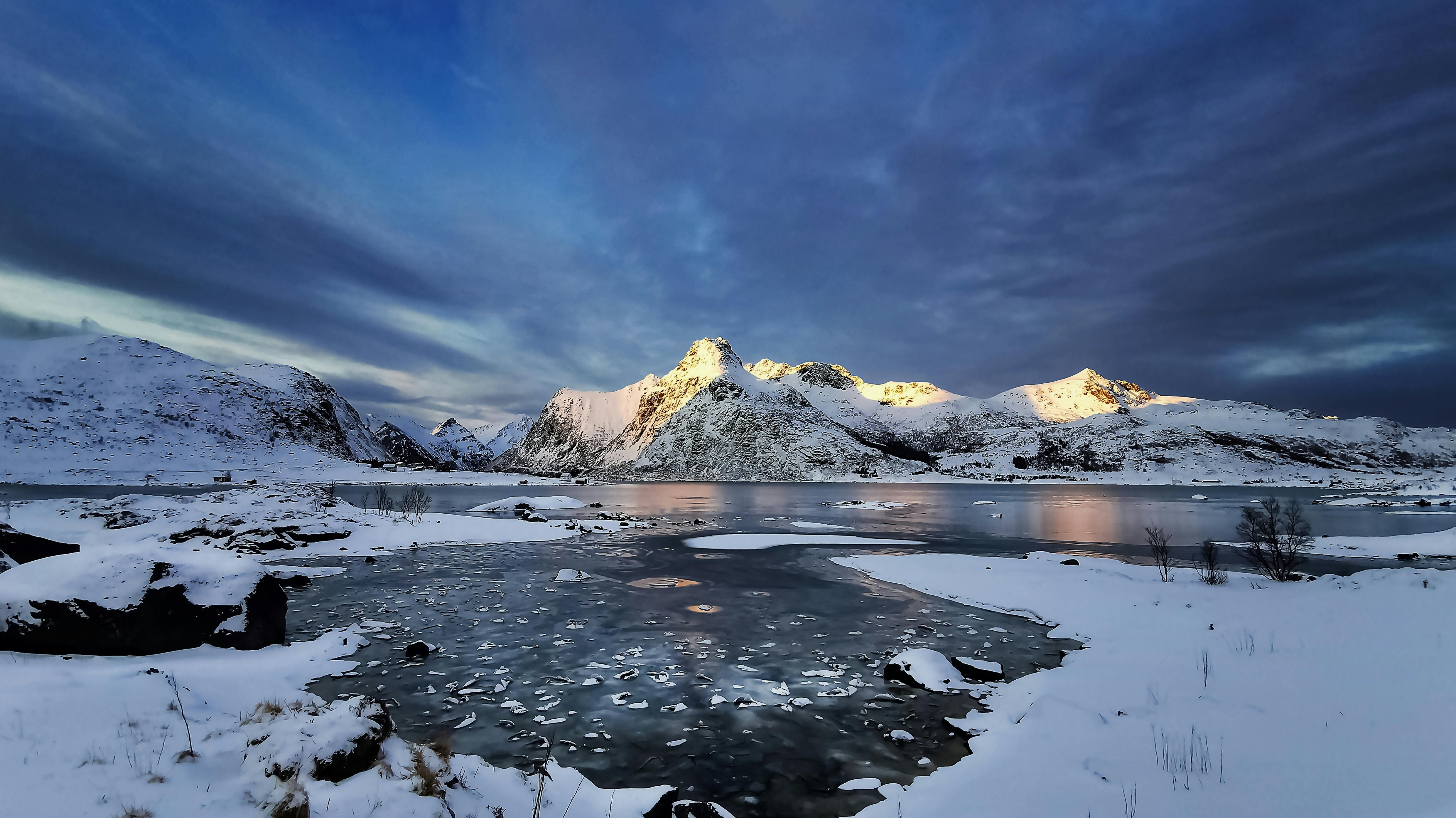 Freezing Lake Surrounded by Snow-capped Mountains · Free Stock Photo