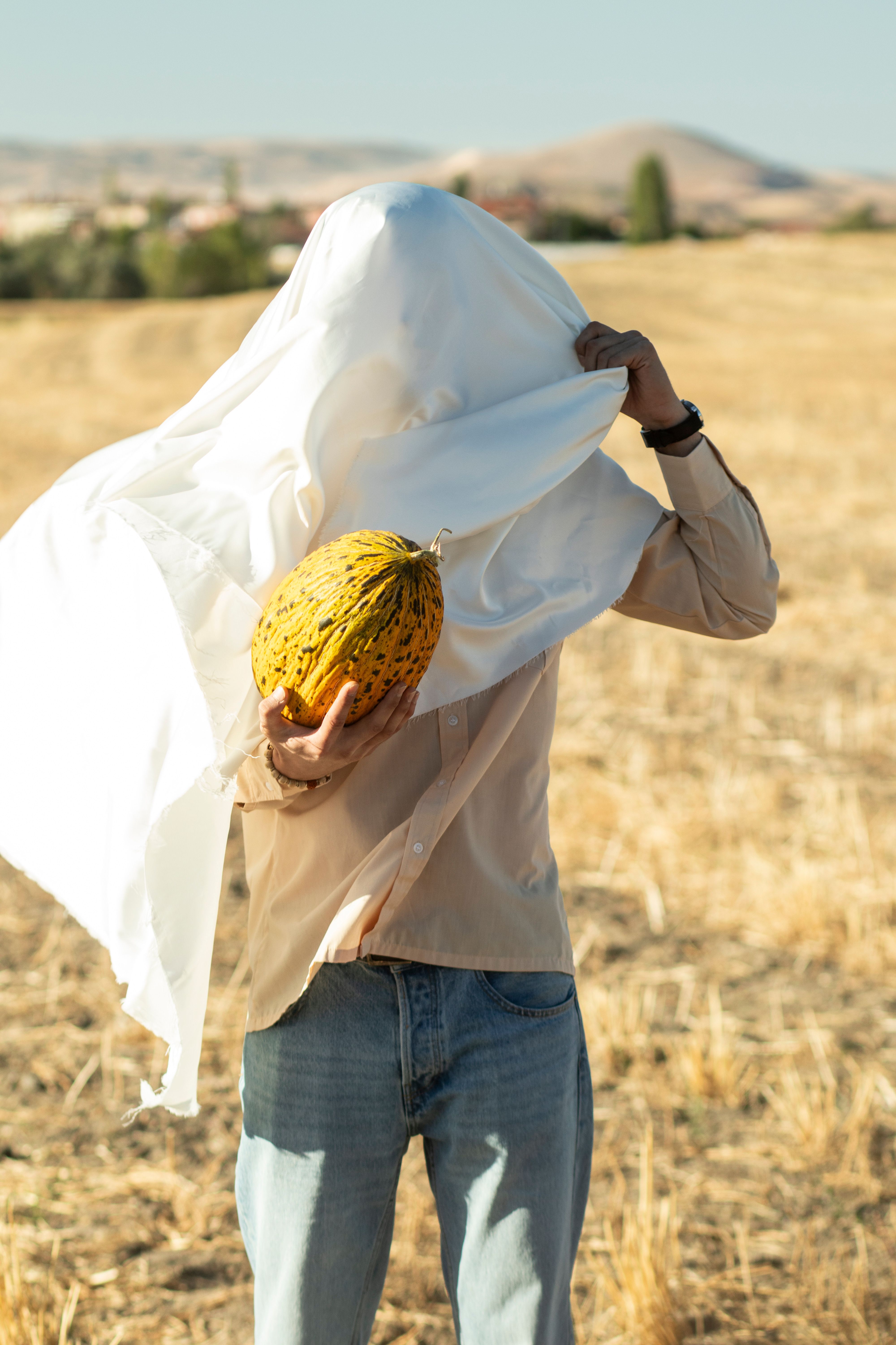 Man With Sheets Holding a Melon · Free Stock Photo