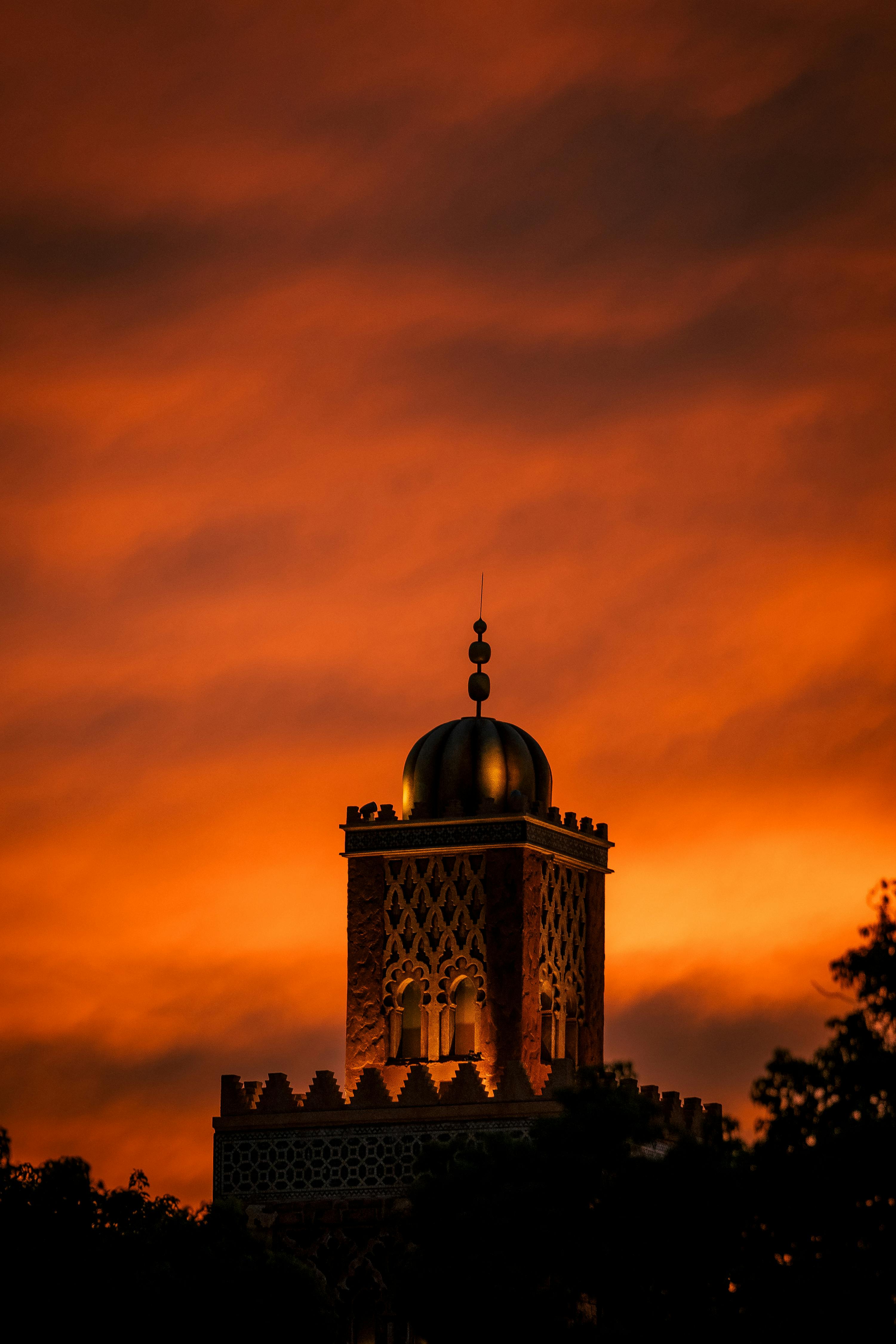 Tower with Dome under Dramatic Sky at Sunset · Free Stock Photo