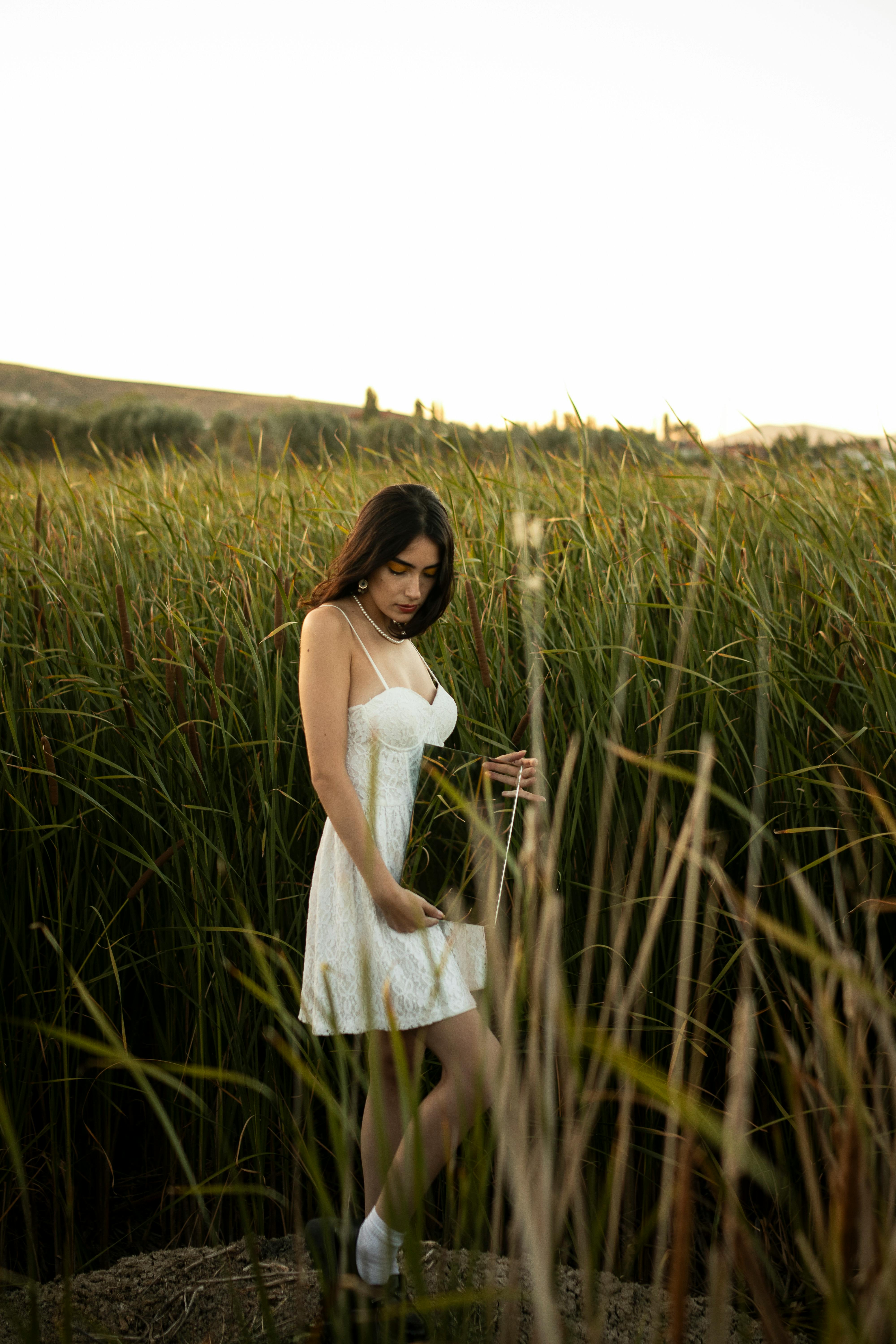 Portrait of a Female Model Wearing a White Dress Standing in a Field ...