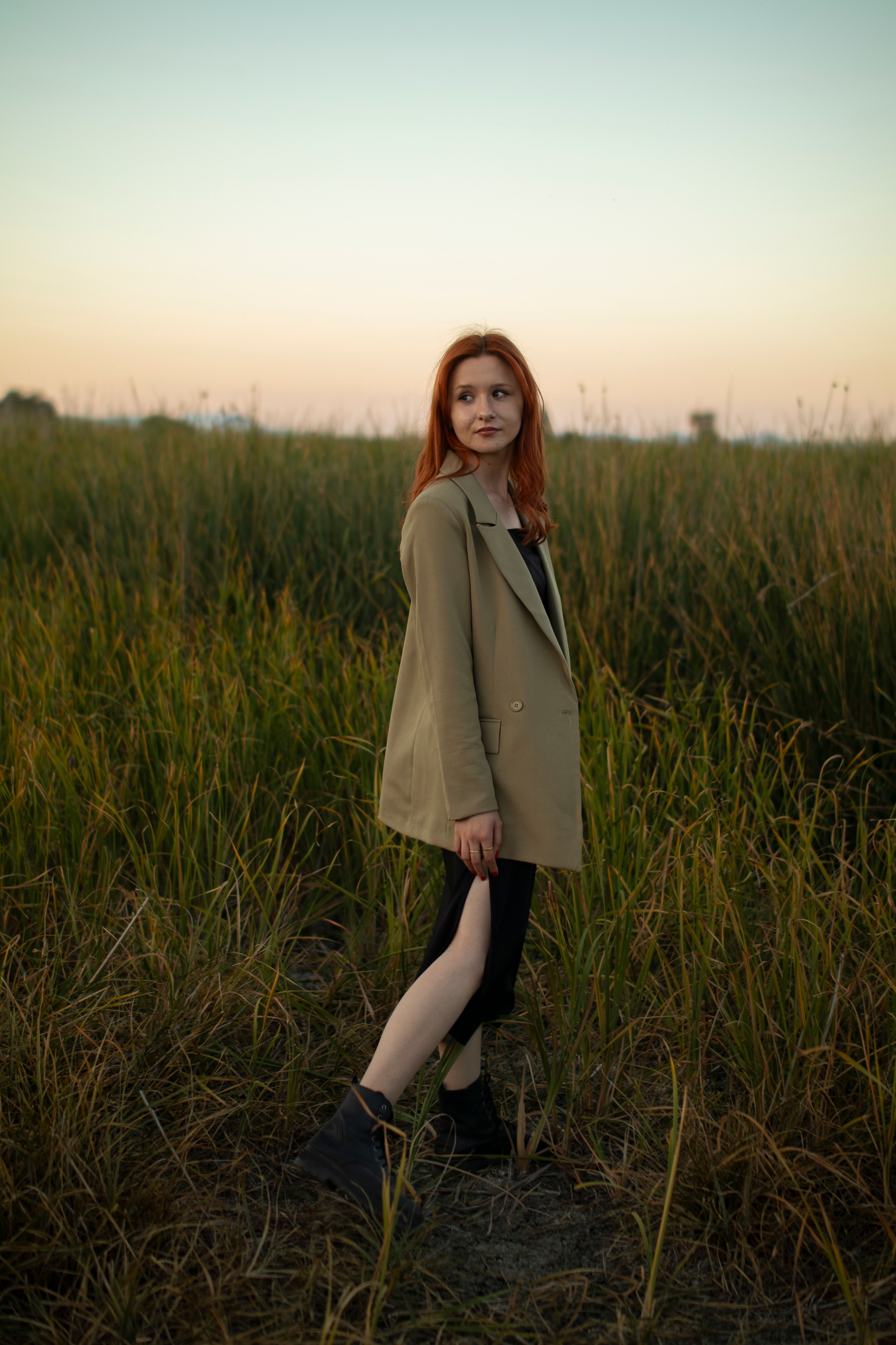Young Red Haired Woman In Olive Blazer And Black Split Midi Skirt