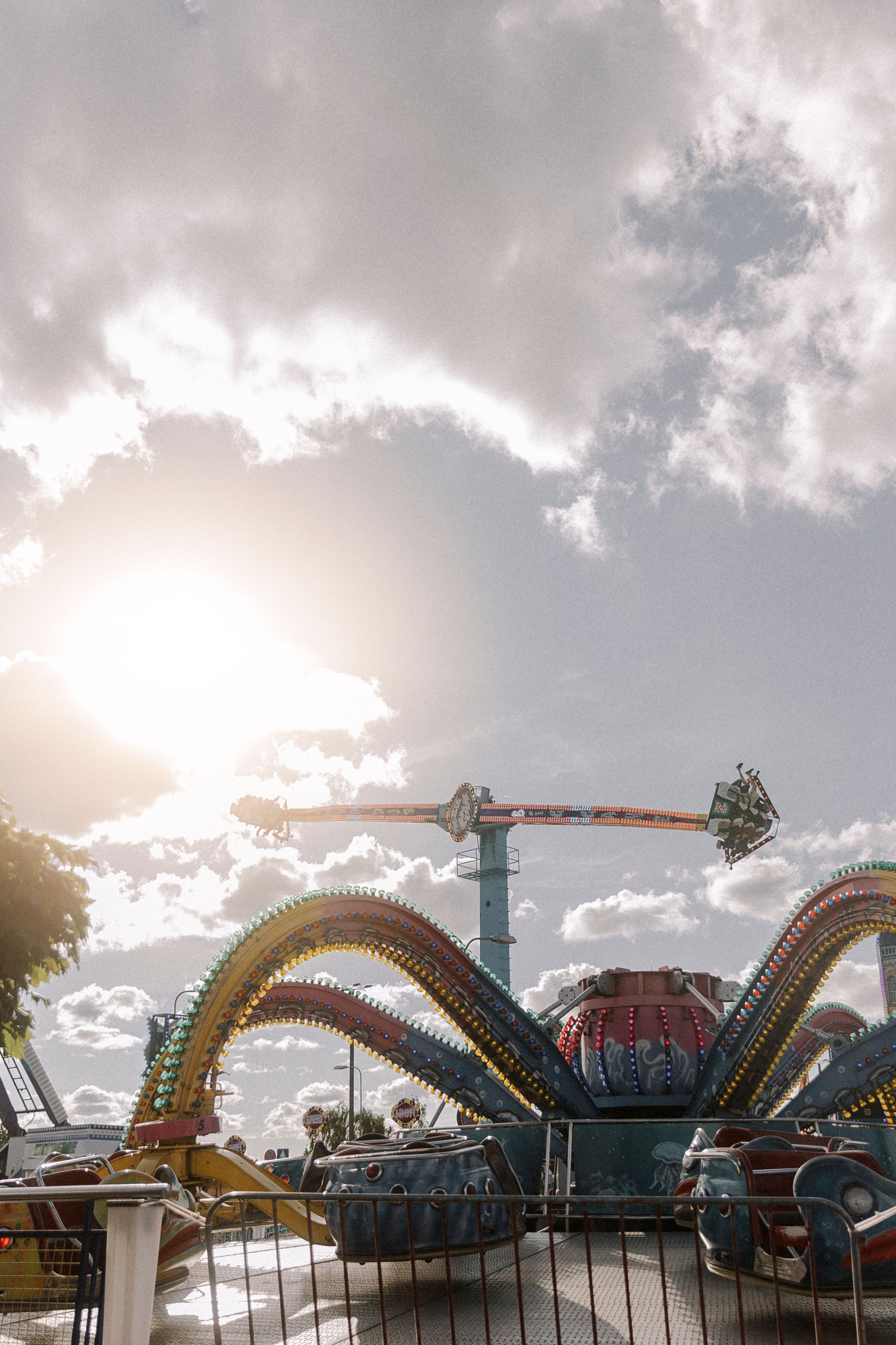 Rides in Amusement Park under Cloudy Sky Illuminated by Setting Sun ...