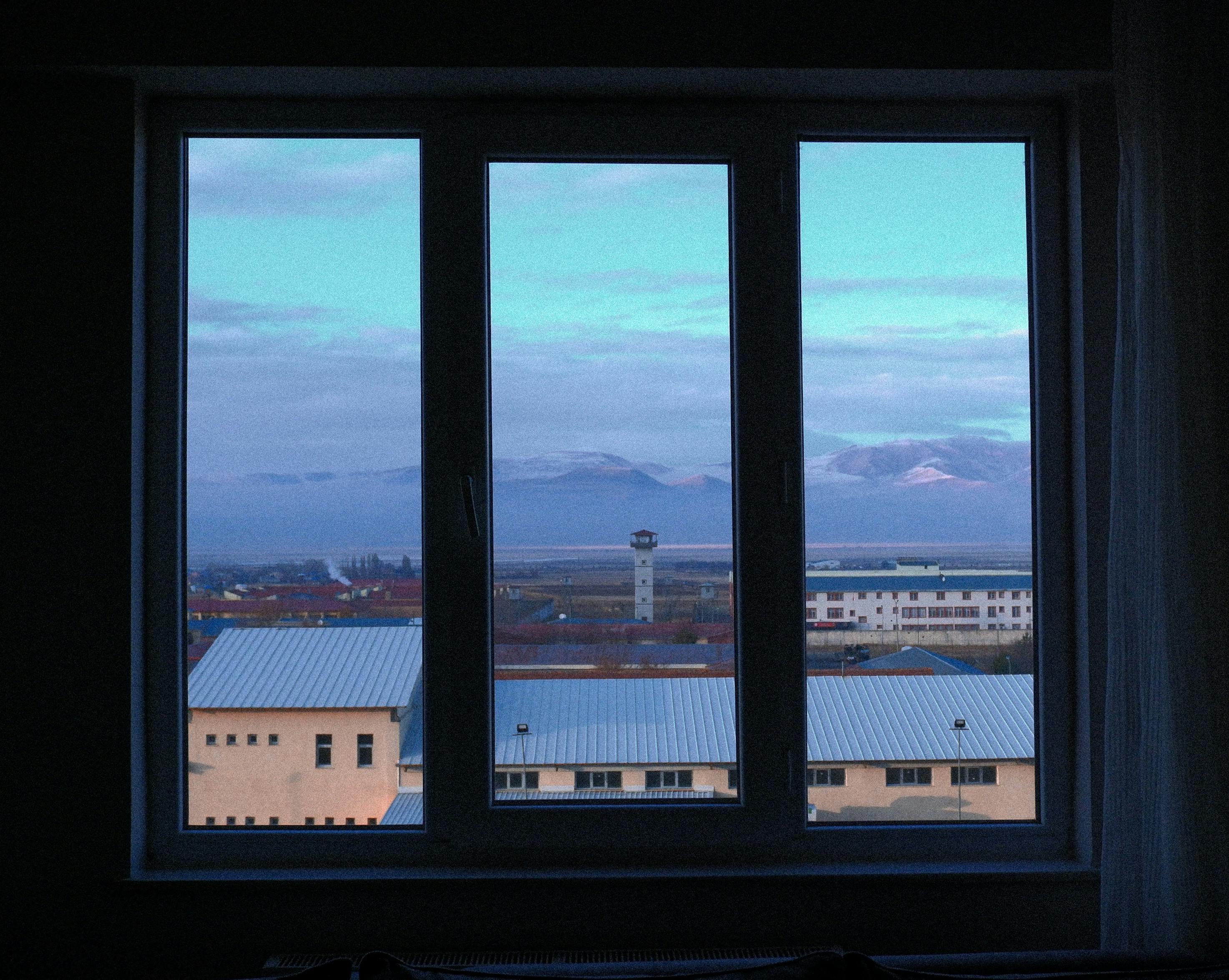 Buildings Roofs behind Windows · Free Stock Photo