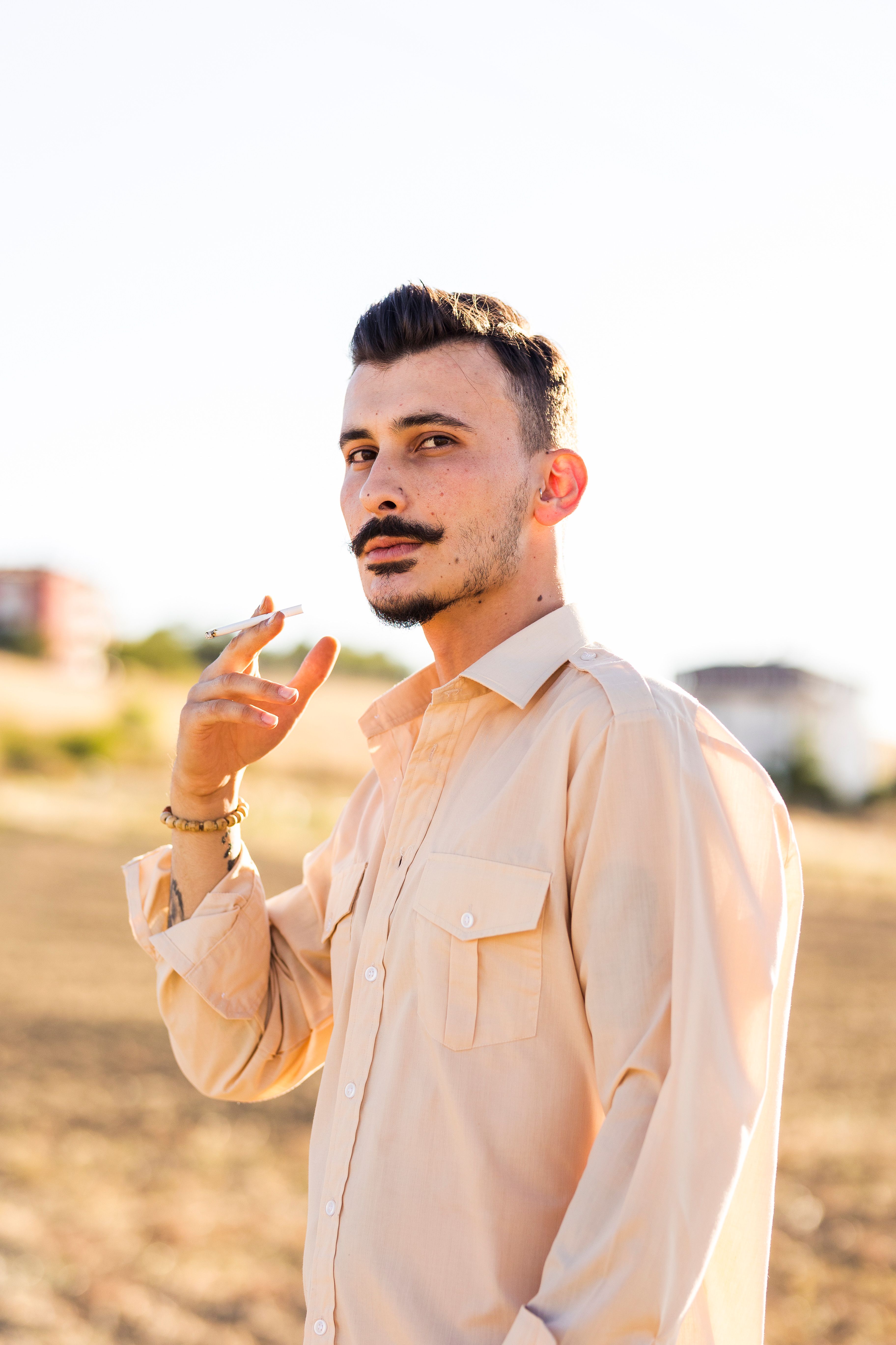 Brunette in Sepia Shirt Smoking Cigarette · Free Stock Photo