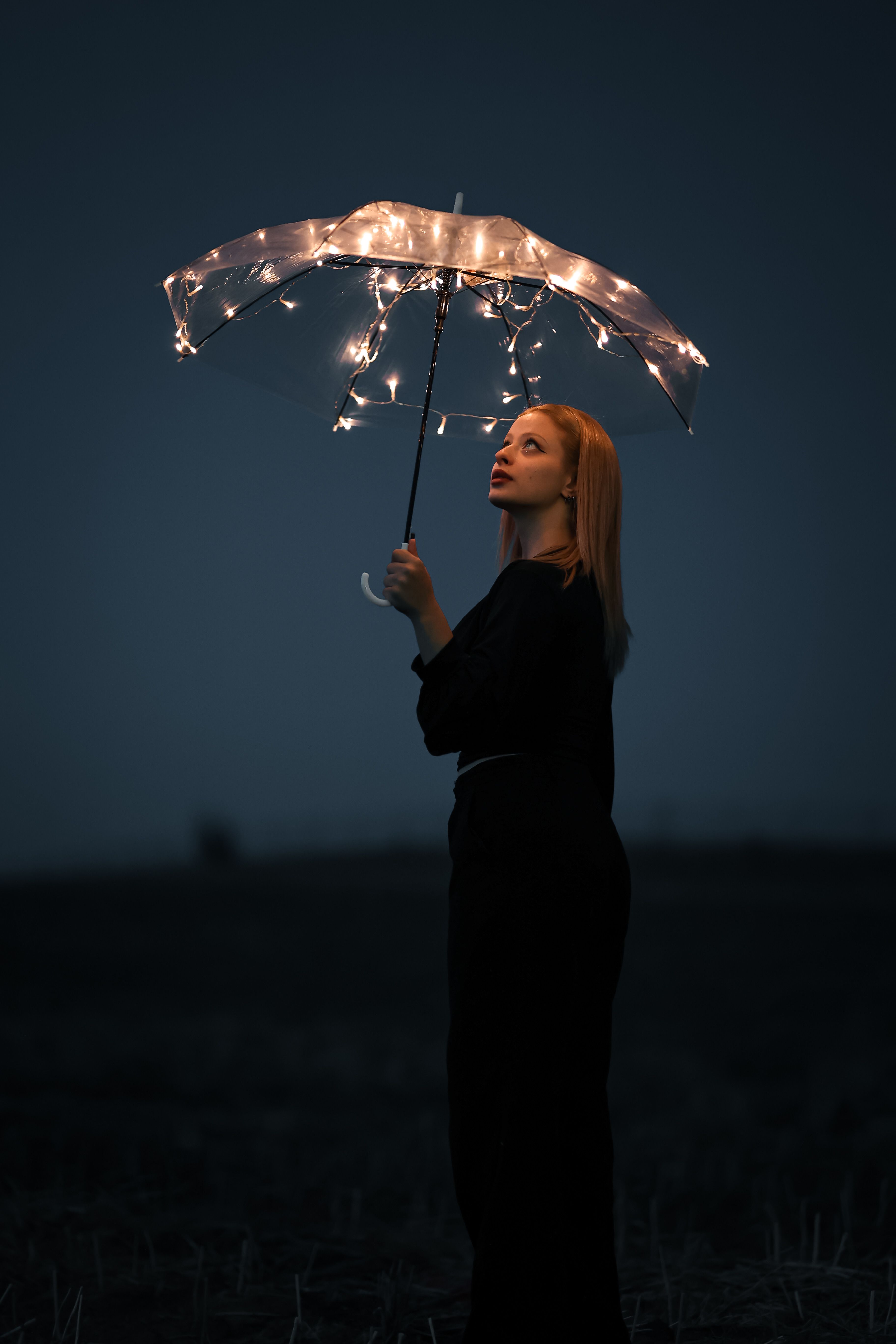 Woman Posing with Umbrella with Lights at Night · Free Stock Photo