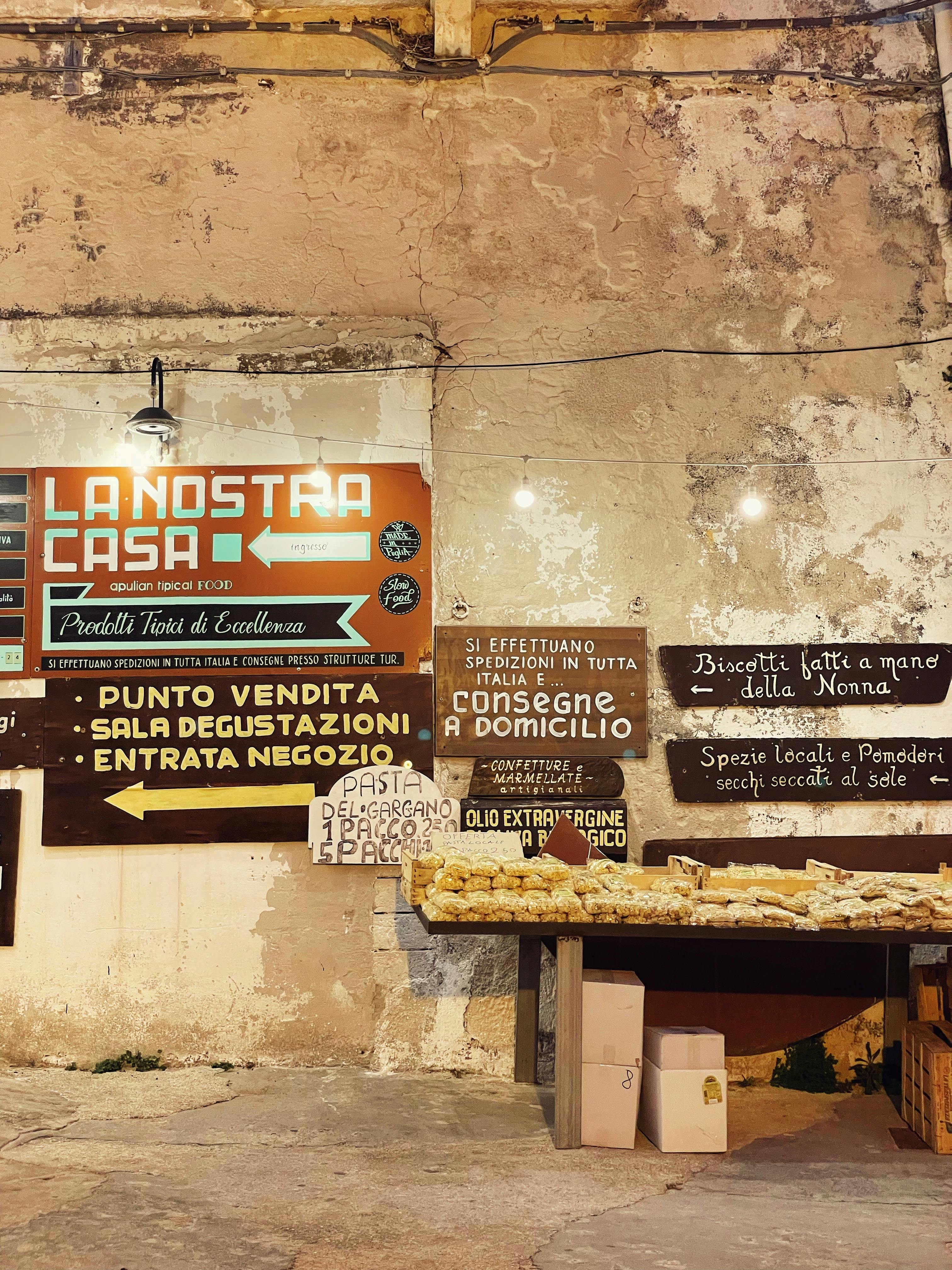 A Stall and Signs on an Italian Street · Free Stock Photo