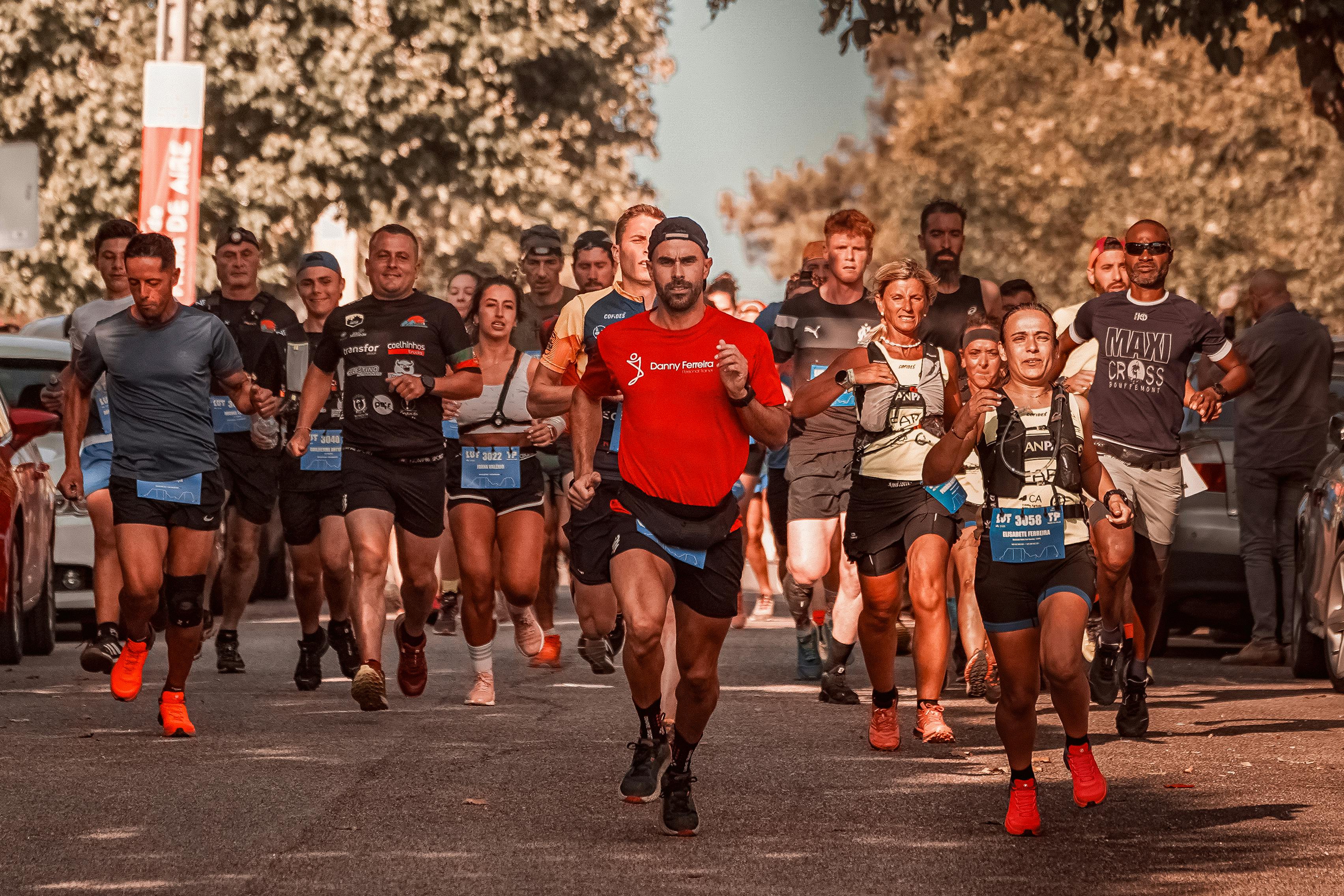 Group of Athletes Running on a Street at a Marathon Race · Free Stock Photo