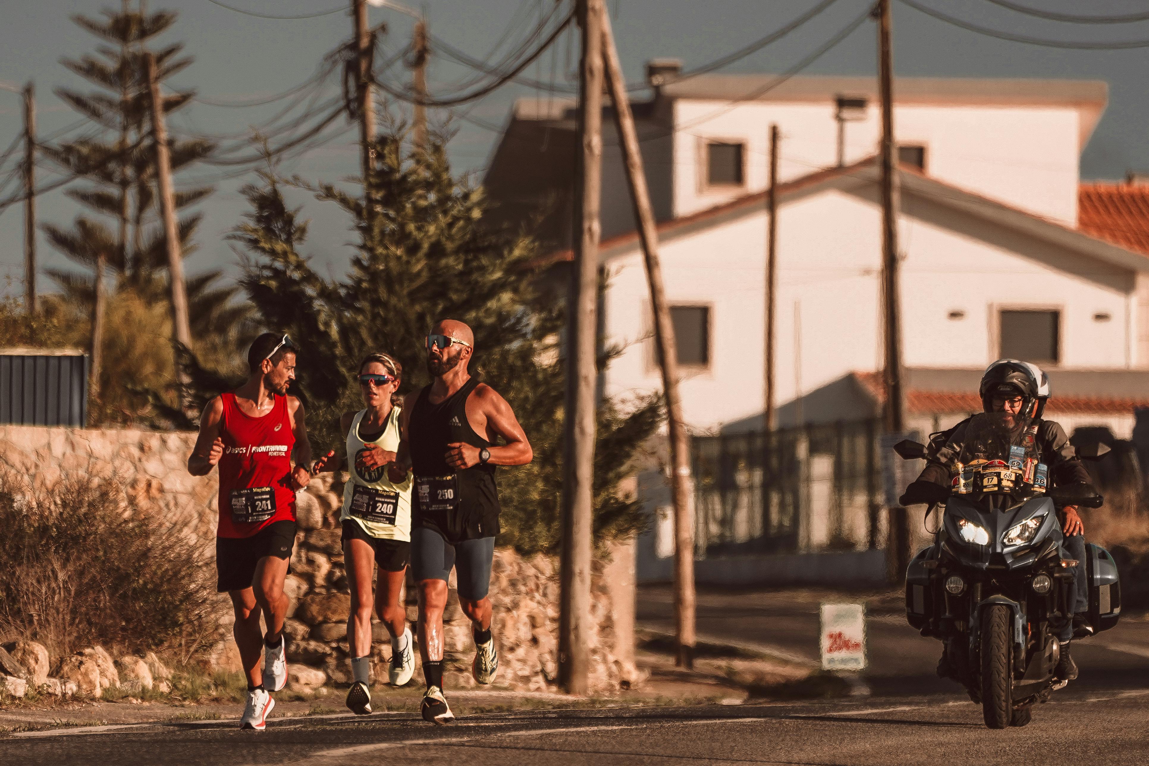Woman and Men Running in Street Race in Town · Free Stock Photo