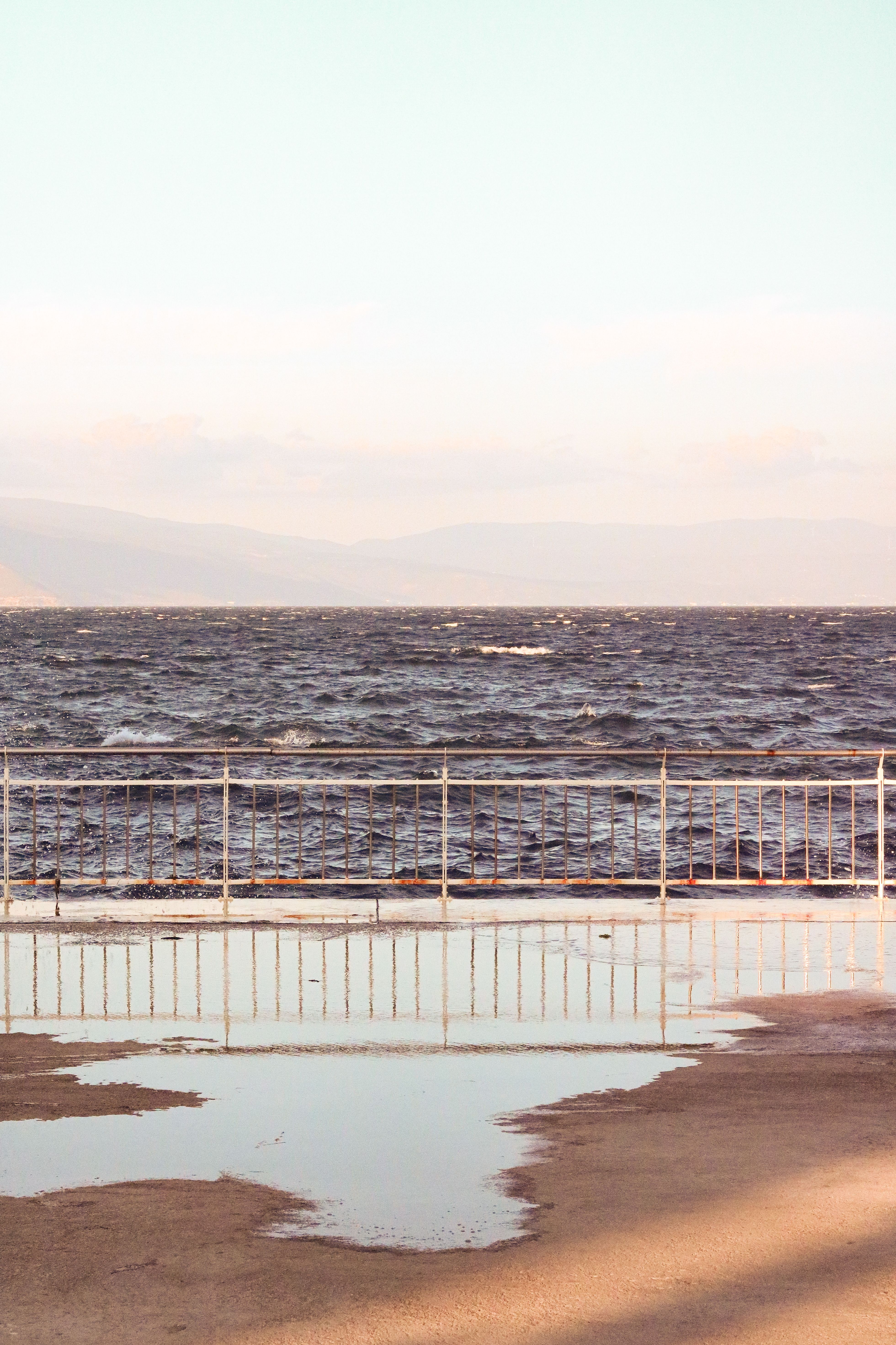 Puddle on Beach with Railing on Sea Shore · Free Stock Photo