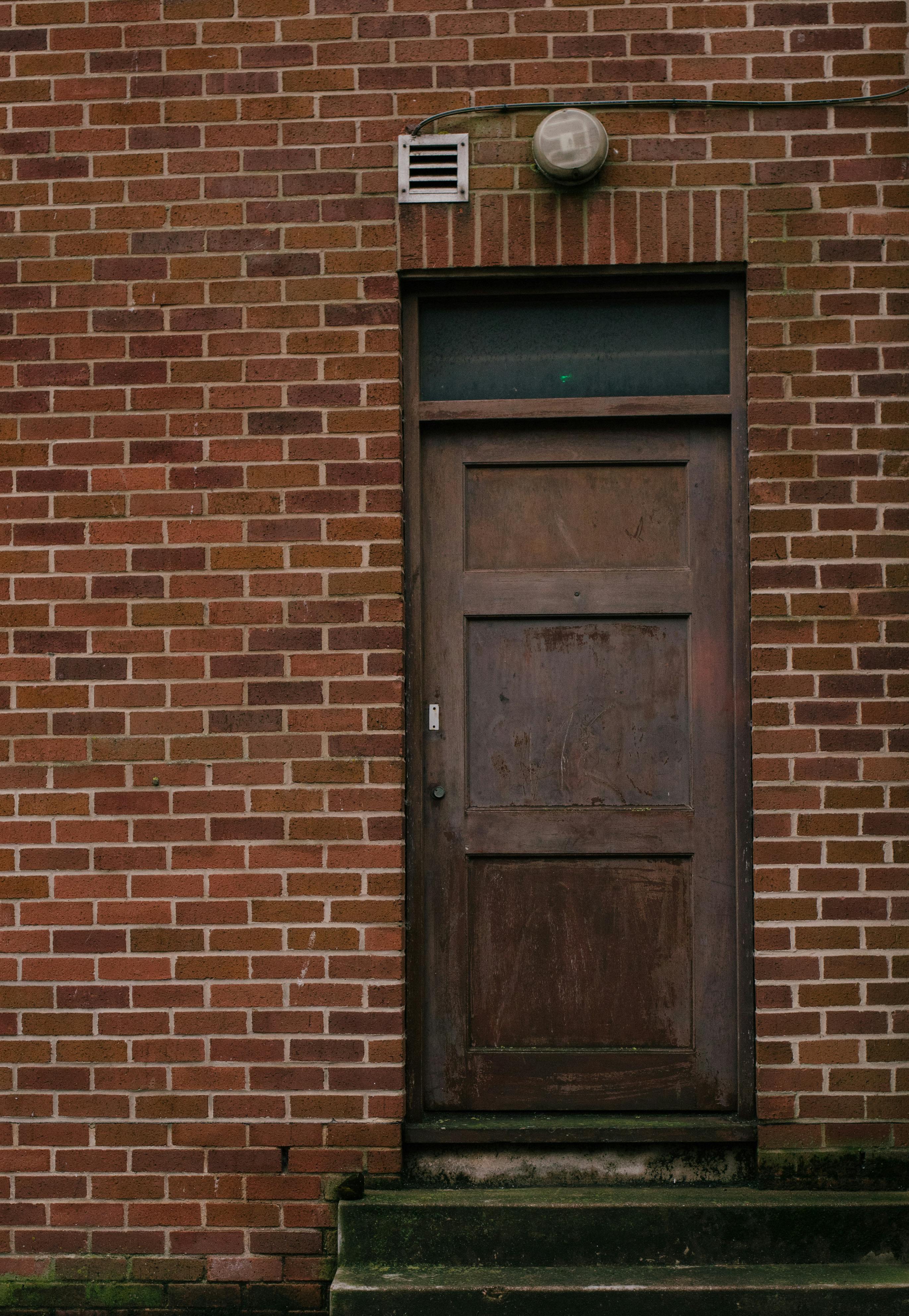 Wooden Door in a Brick Building · Free Stock Photo