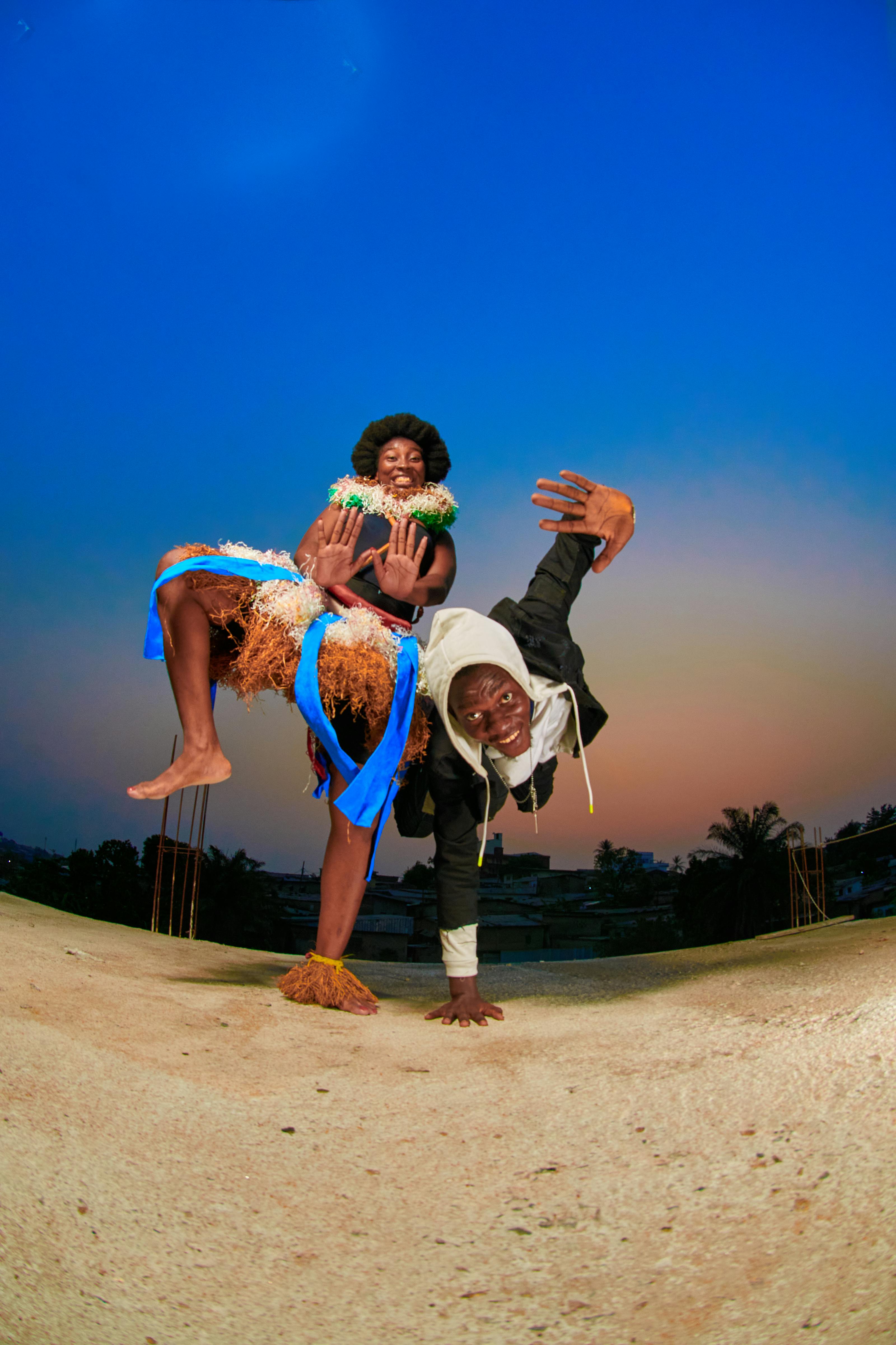 Man in Hoodie Standing on One Hand · Free Stock Photo