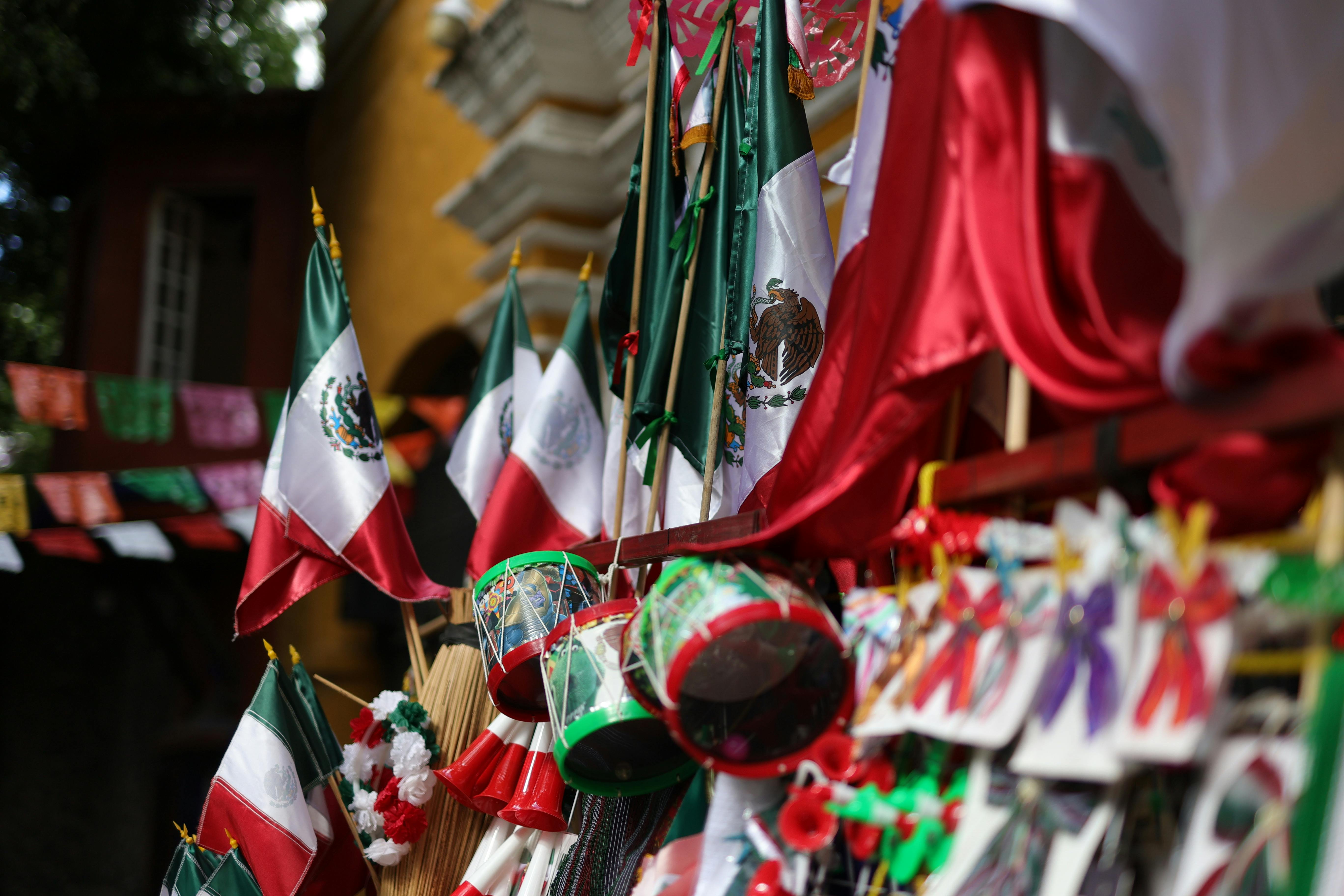 Mexican flags and other decorations are displayed on a street · Free ...