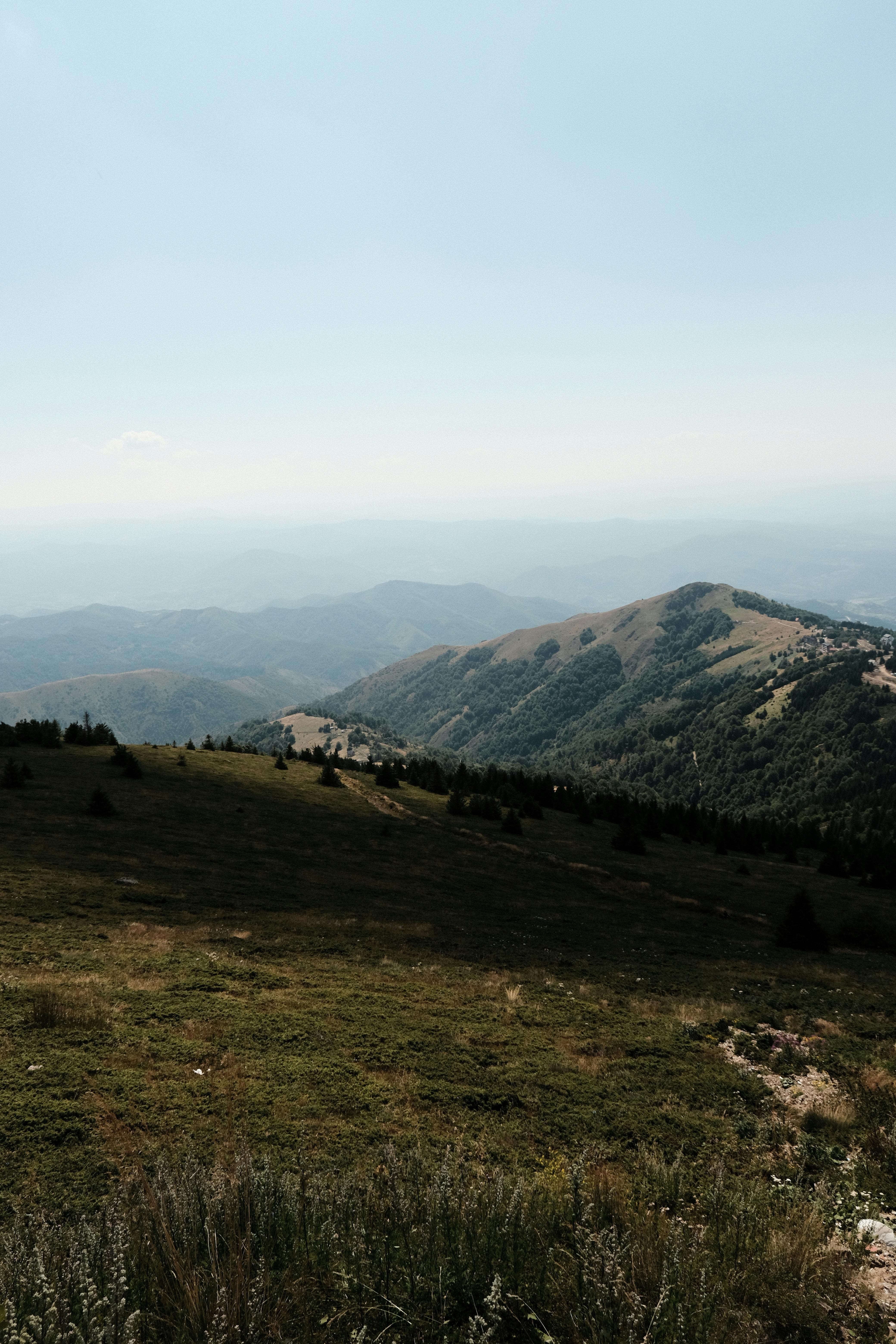 A view of the mountains from the top of a hill · Free Stock Photo
