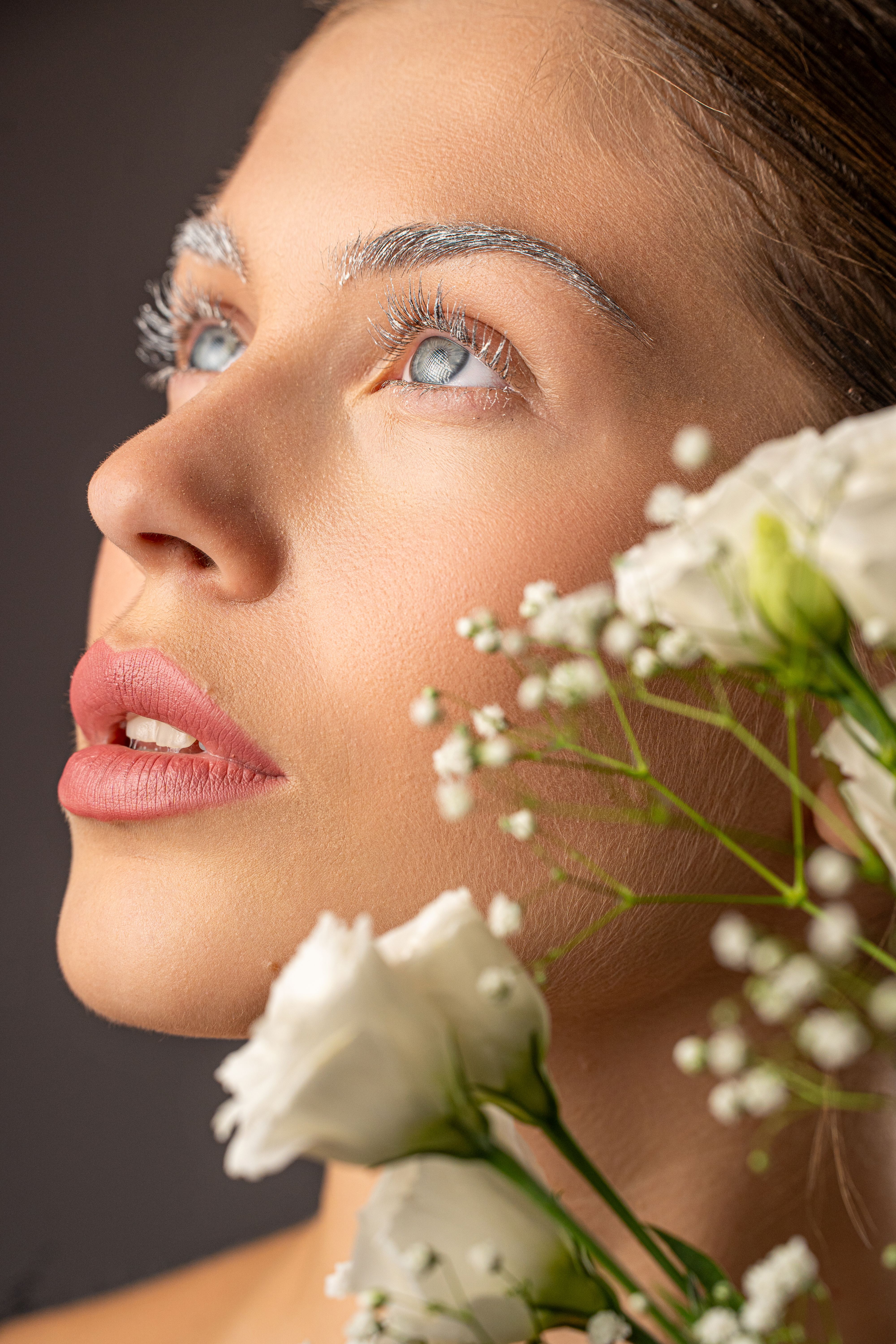 Portrait of a Young Woman with White Flowers · Free Stock Photo
