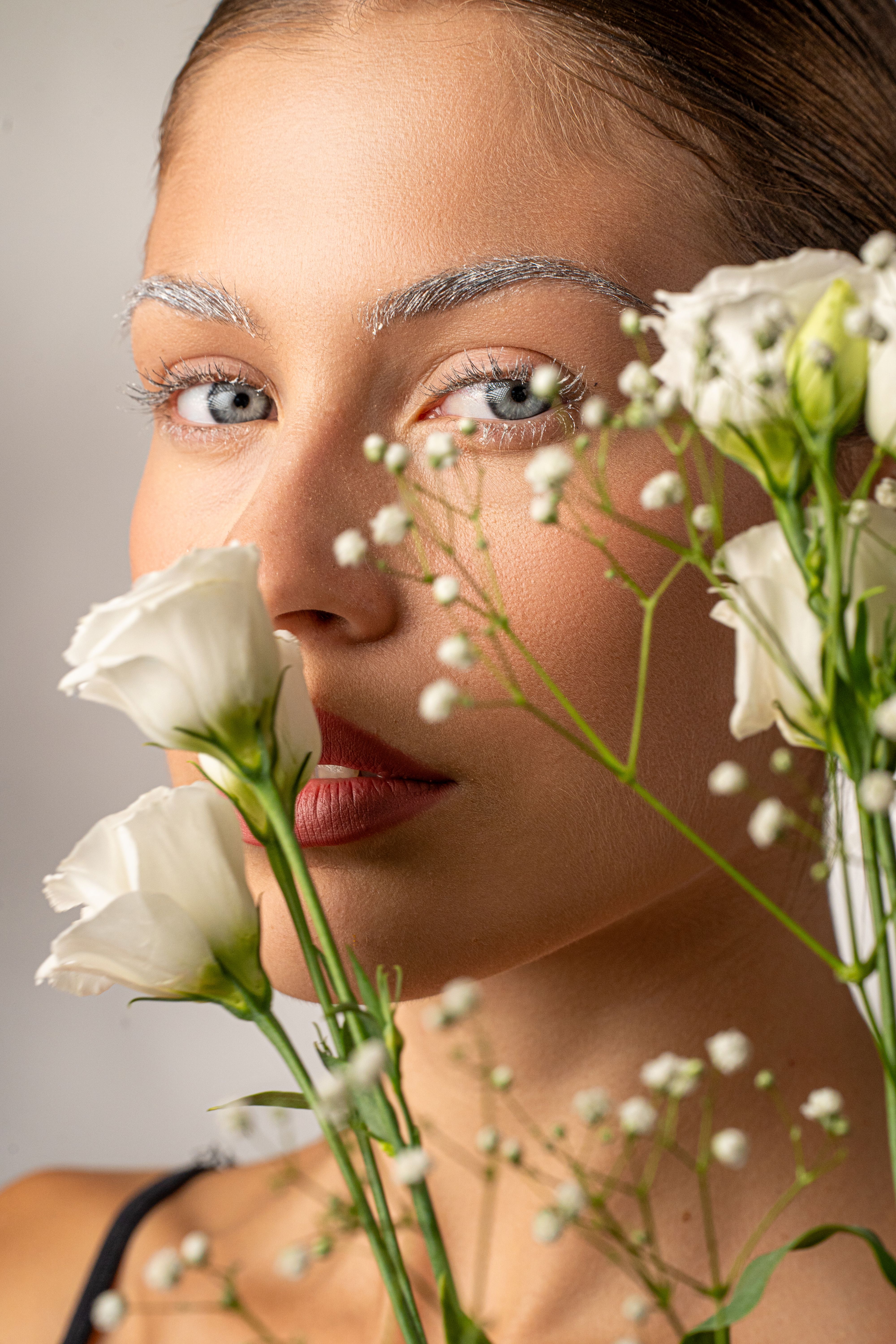 Portrait of a Young Woman with White Flowers · Free Stock Photo