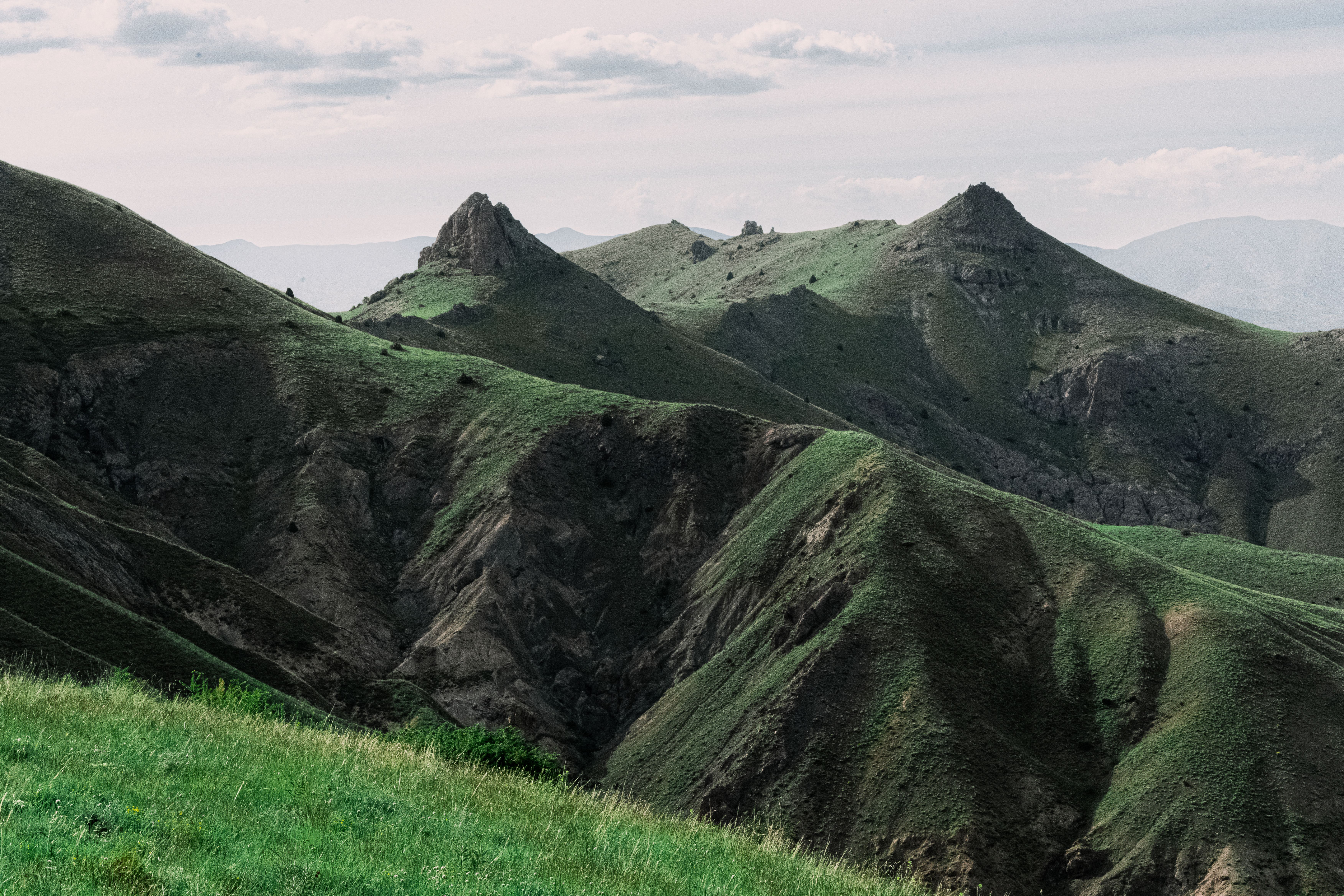 Rocky Slopes of a Mountain Range Covered with Grass · Free Stock Photo