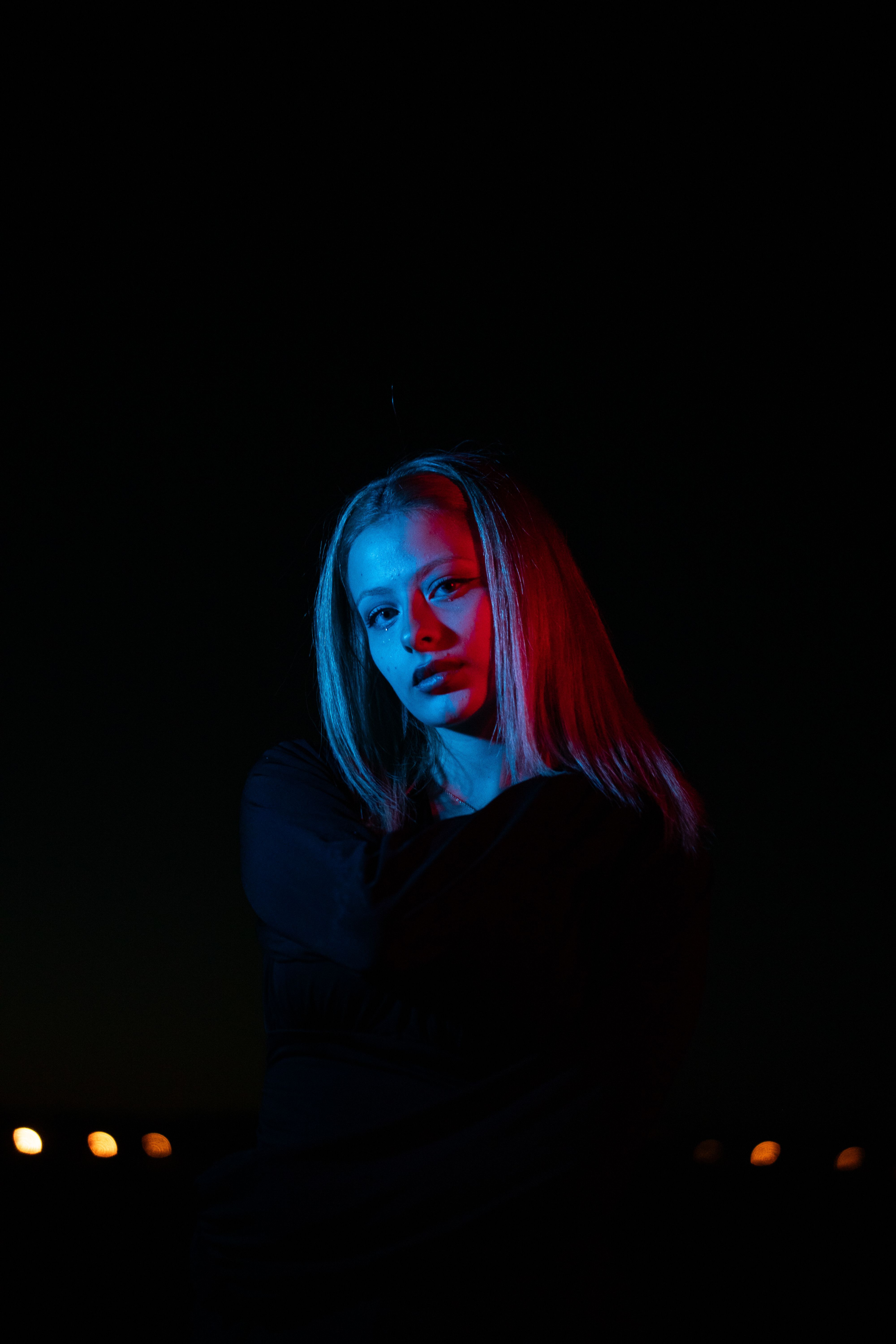 Young Woman Posing Outside in Split Lighting · Free Stock Photo