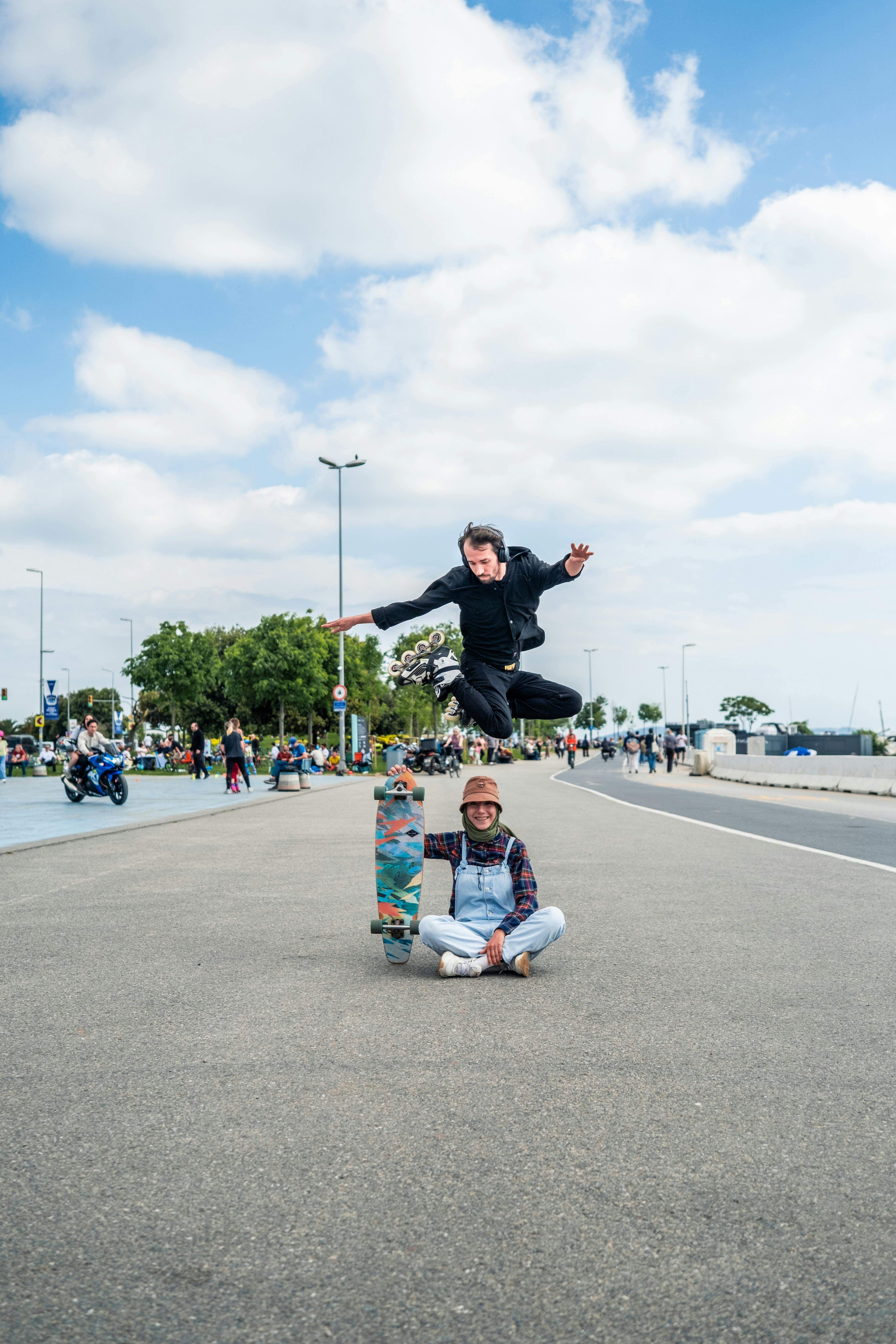 A Man Jumping over a Woman in Skates · Free Stock Photo