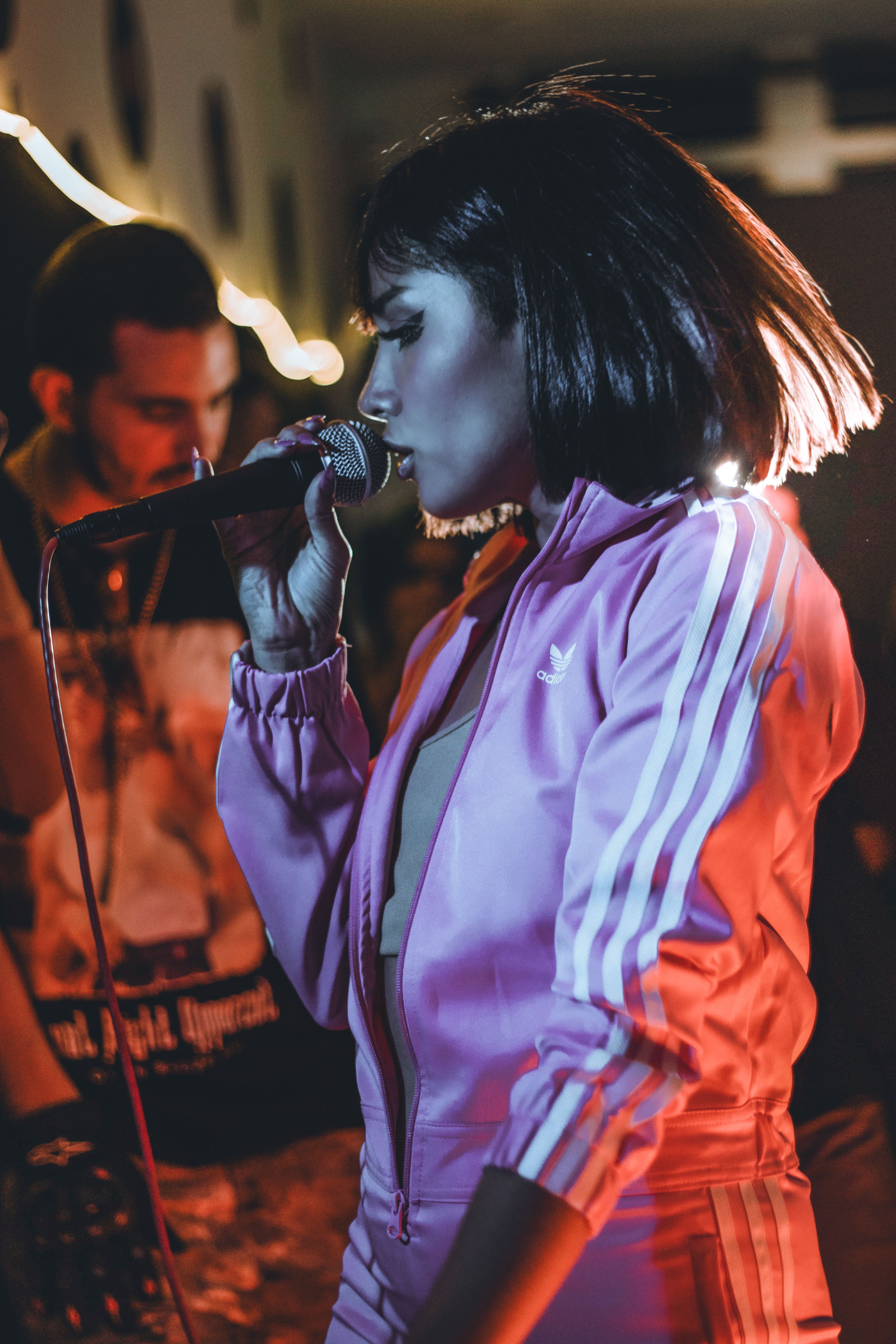 Woman with a Microphone on Stage · Free Stock Photo