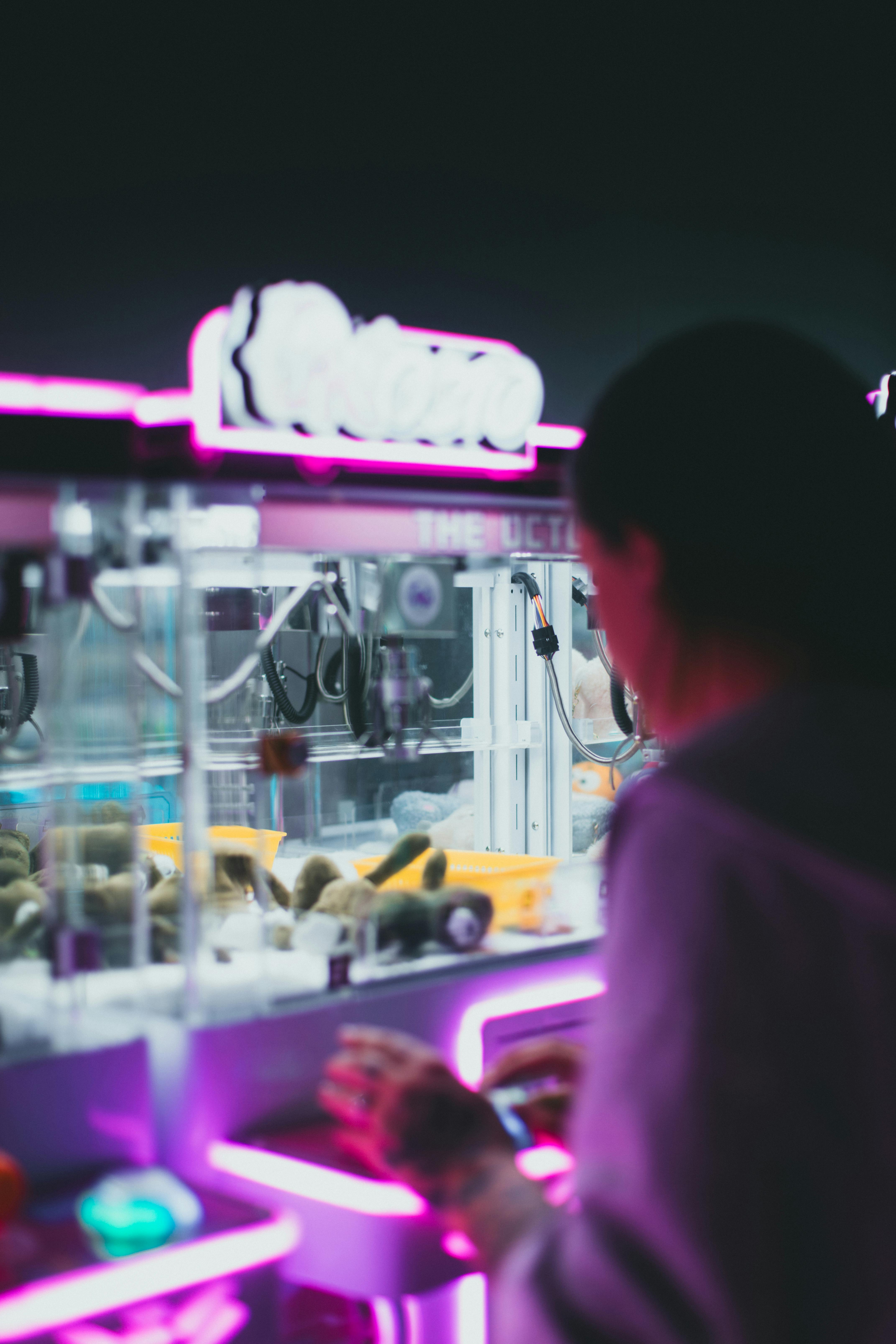 An Illuminated Arcade Machine with Plush Toys · Free Stock Photo