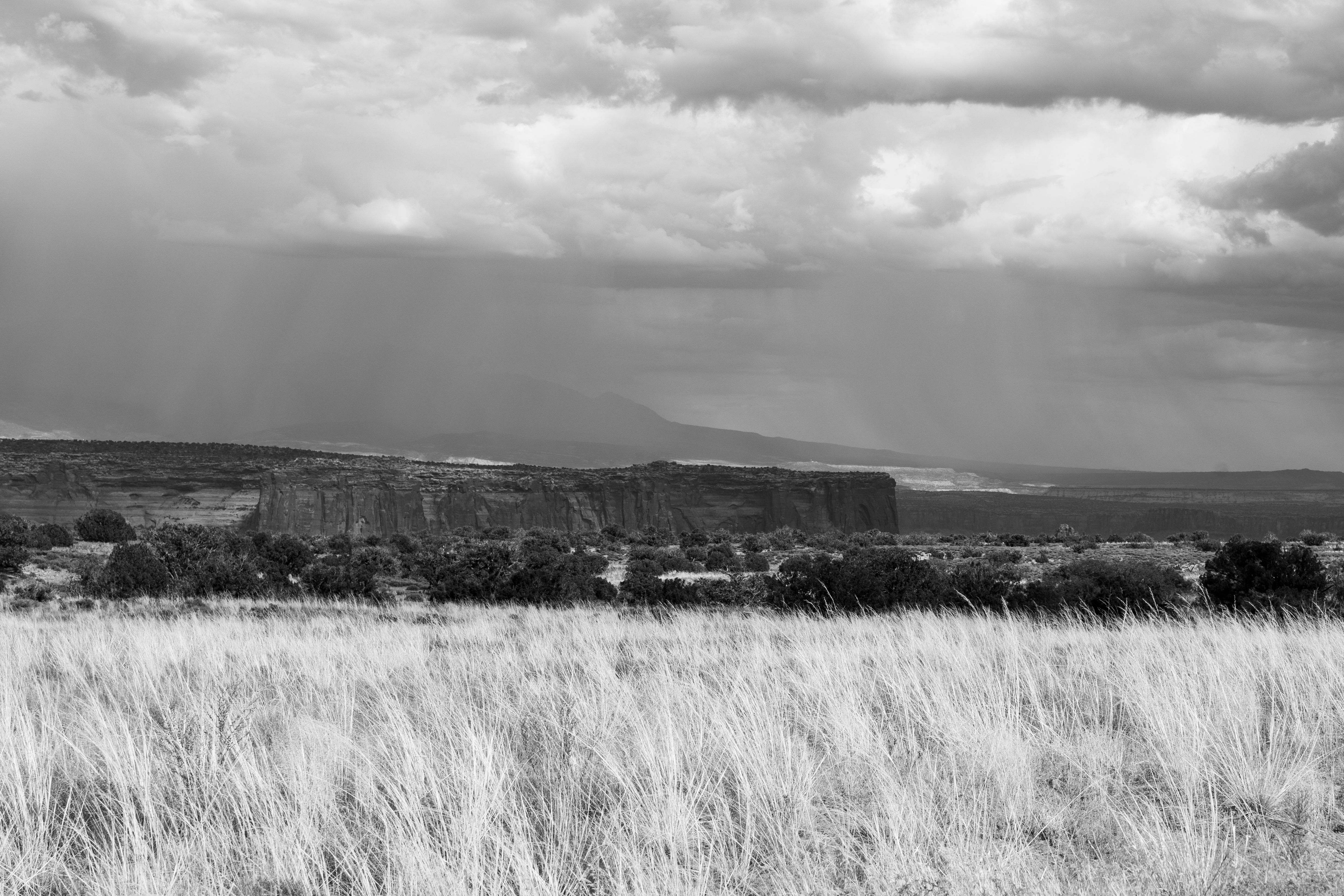 View of a Grass Field and a Cliff in Distance · Free Stock Photo