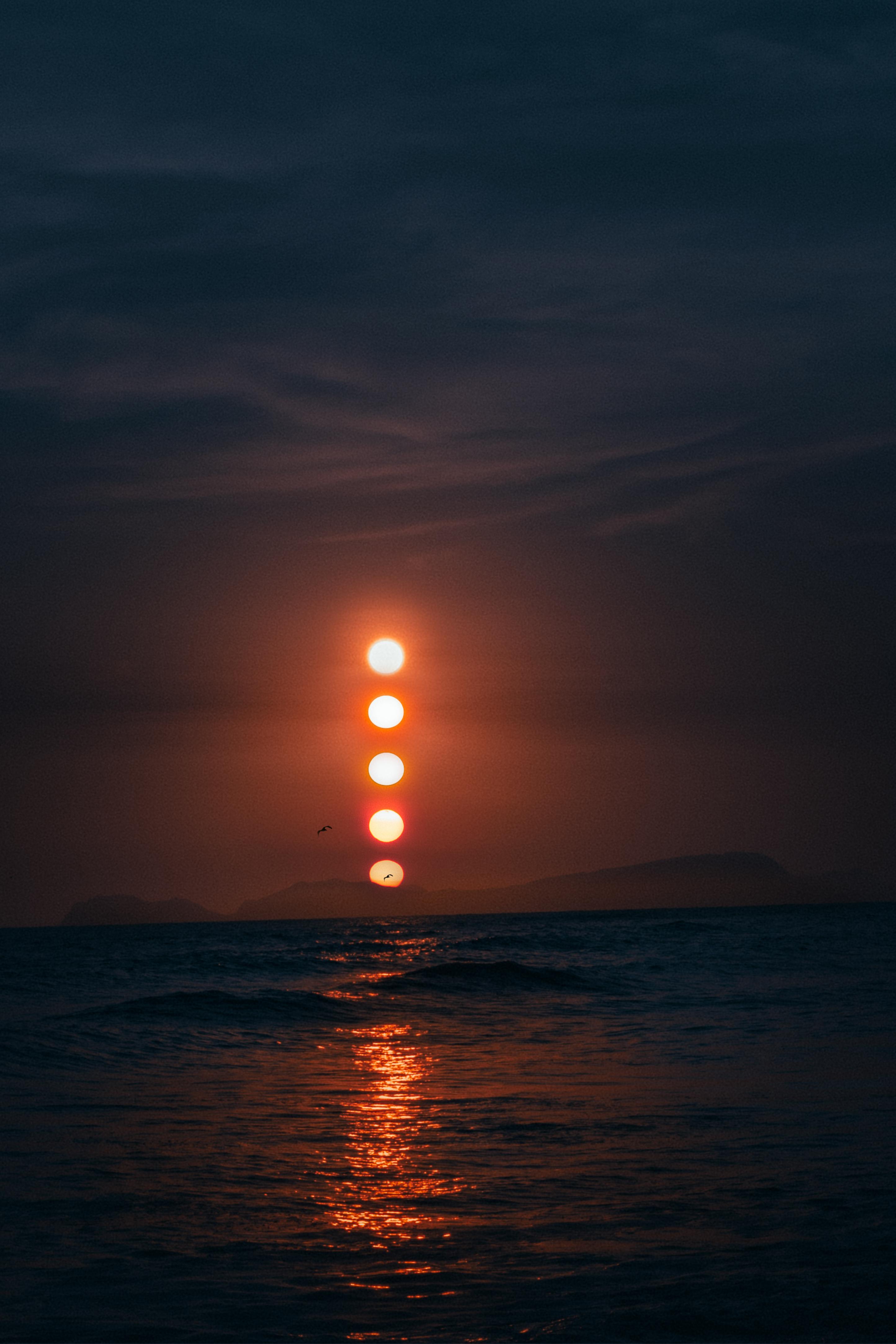 Multiple Exposure Photo of a Sun Setting over Sea · Free Stock Photo