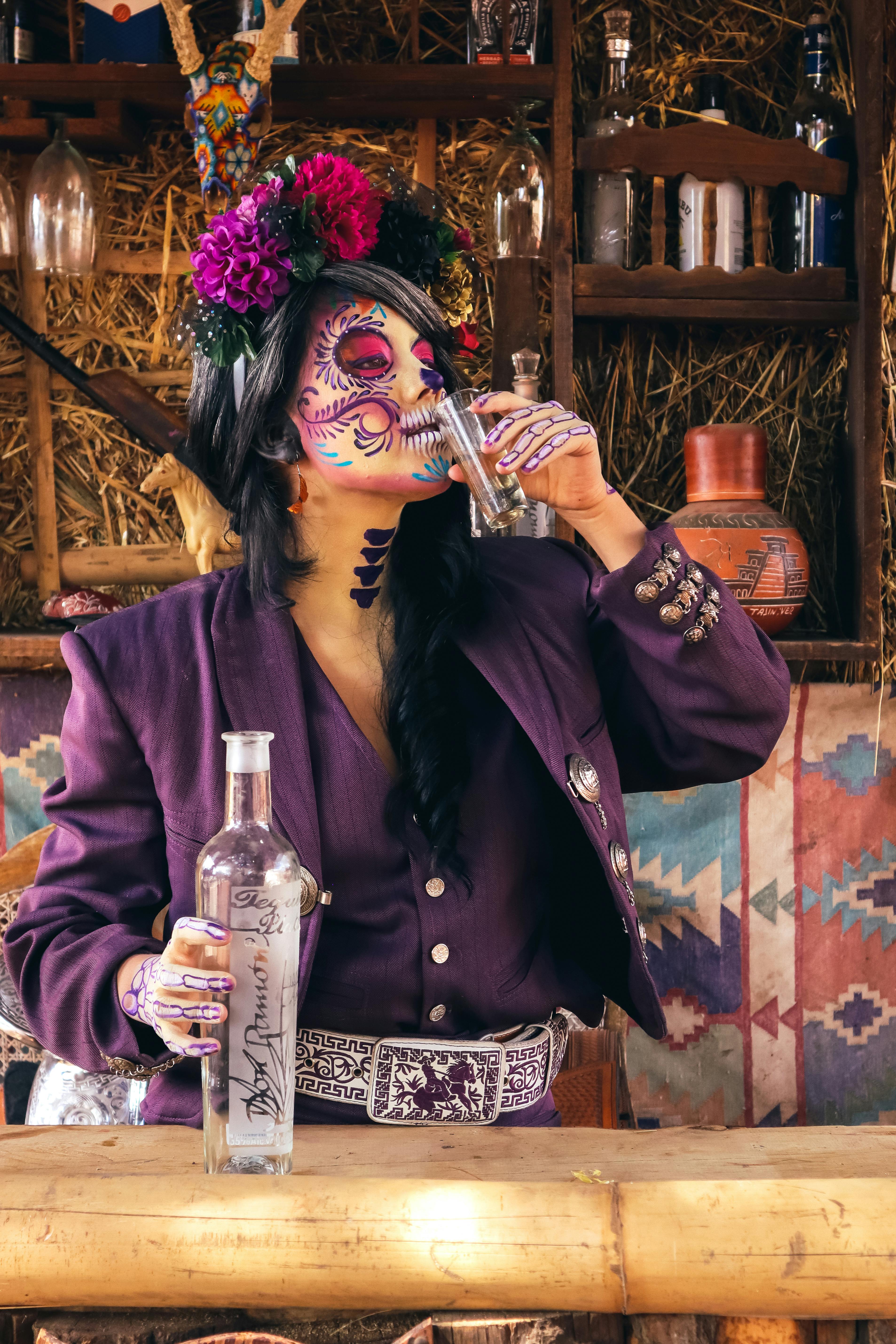 Catrina Drinking Tequila behind Counter · Free Stock Photo