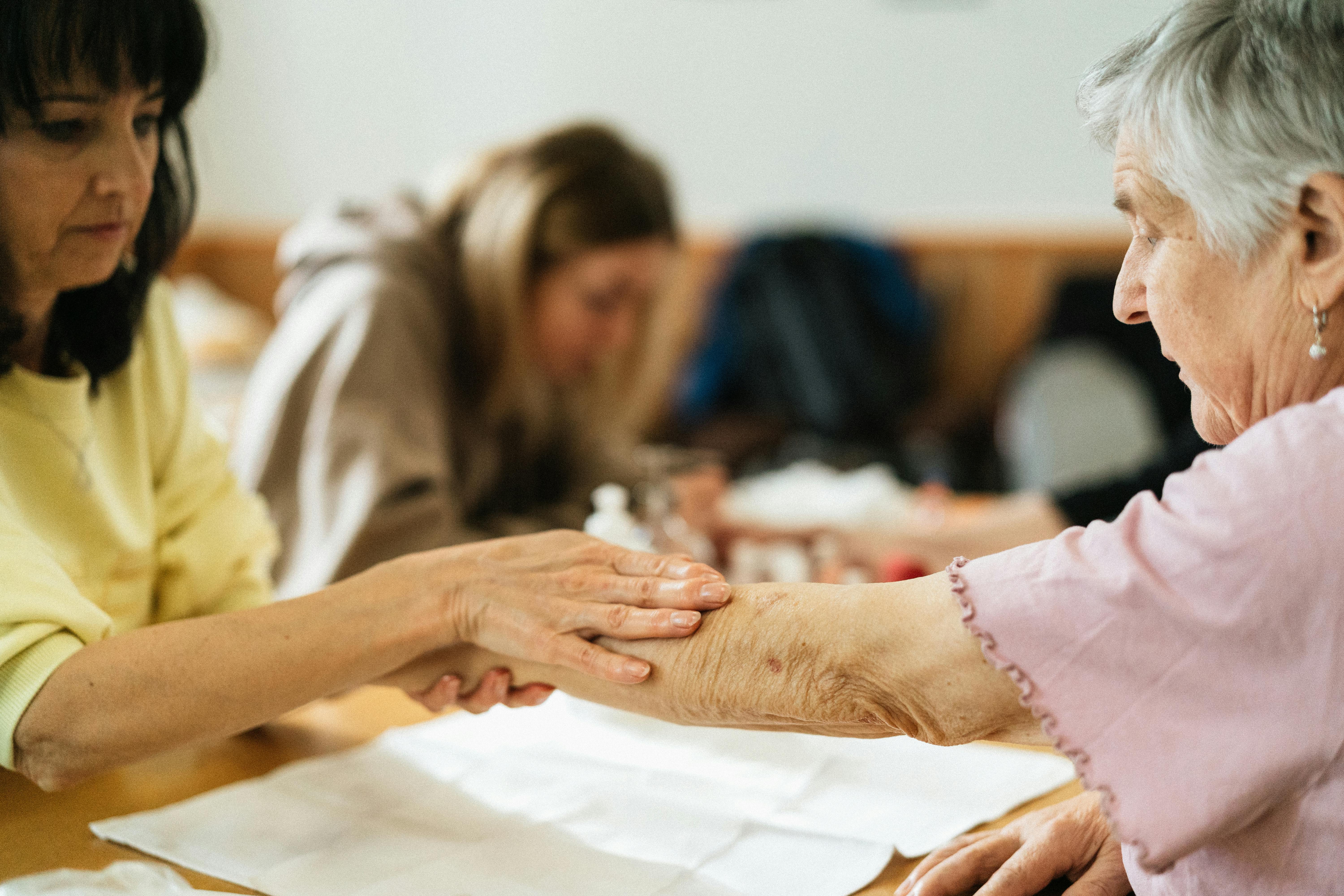 A Woman Touching an Arm · Free Stock Photo